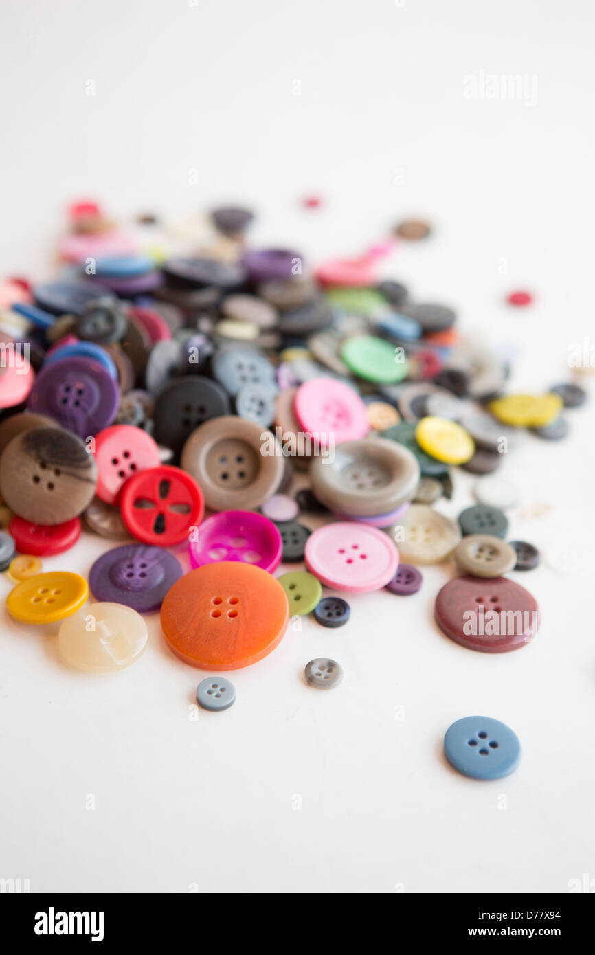 A selection of buttons scattered across a light grey background Stock ...