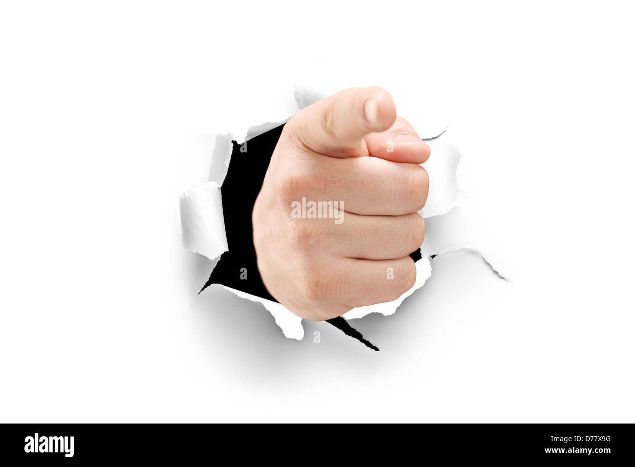 A view of a male hand pointing through a hole in paper isolated on ...