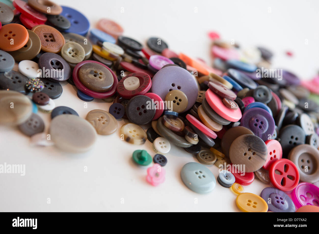 A selection of buttons scattered across a light grey background Stock ...