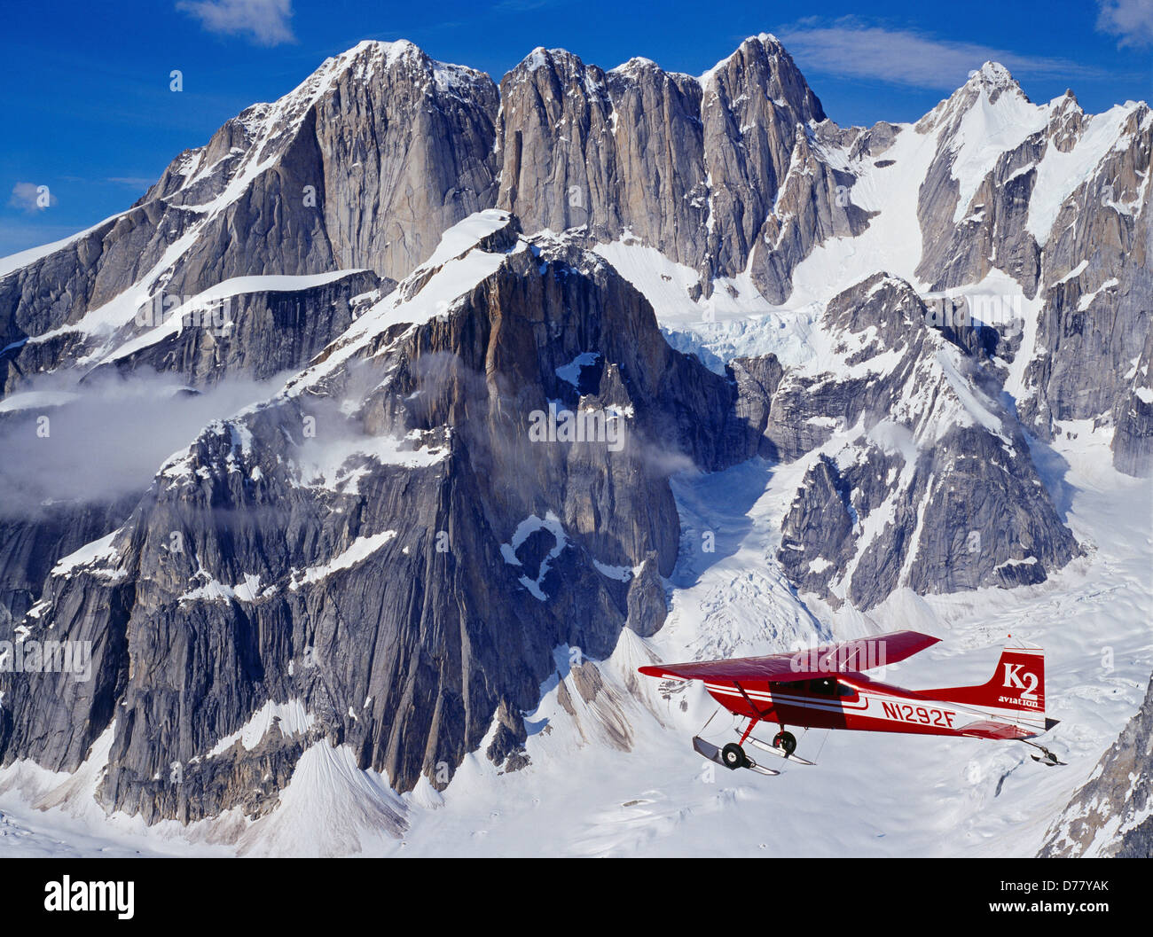 K2 Aviation's Cessna 185 on wheel skis flying up Ruth Gorge past Mooses ...