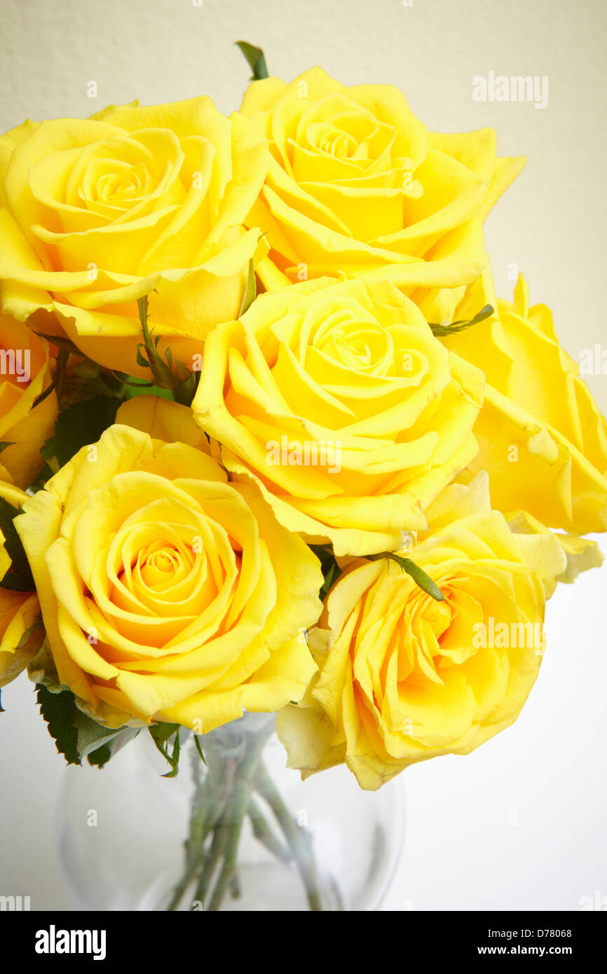 a bundle of yellow flowers in glass vase Stock Photo - Alamy