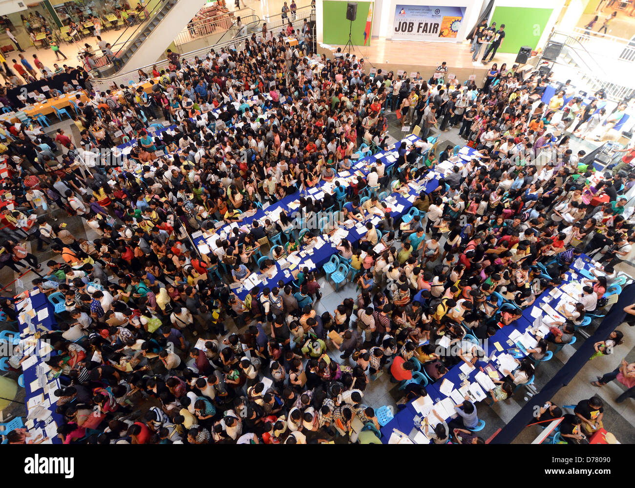 Filipino jobseekers flock to application desks during a job fair inside ...