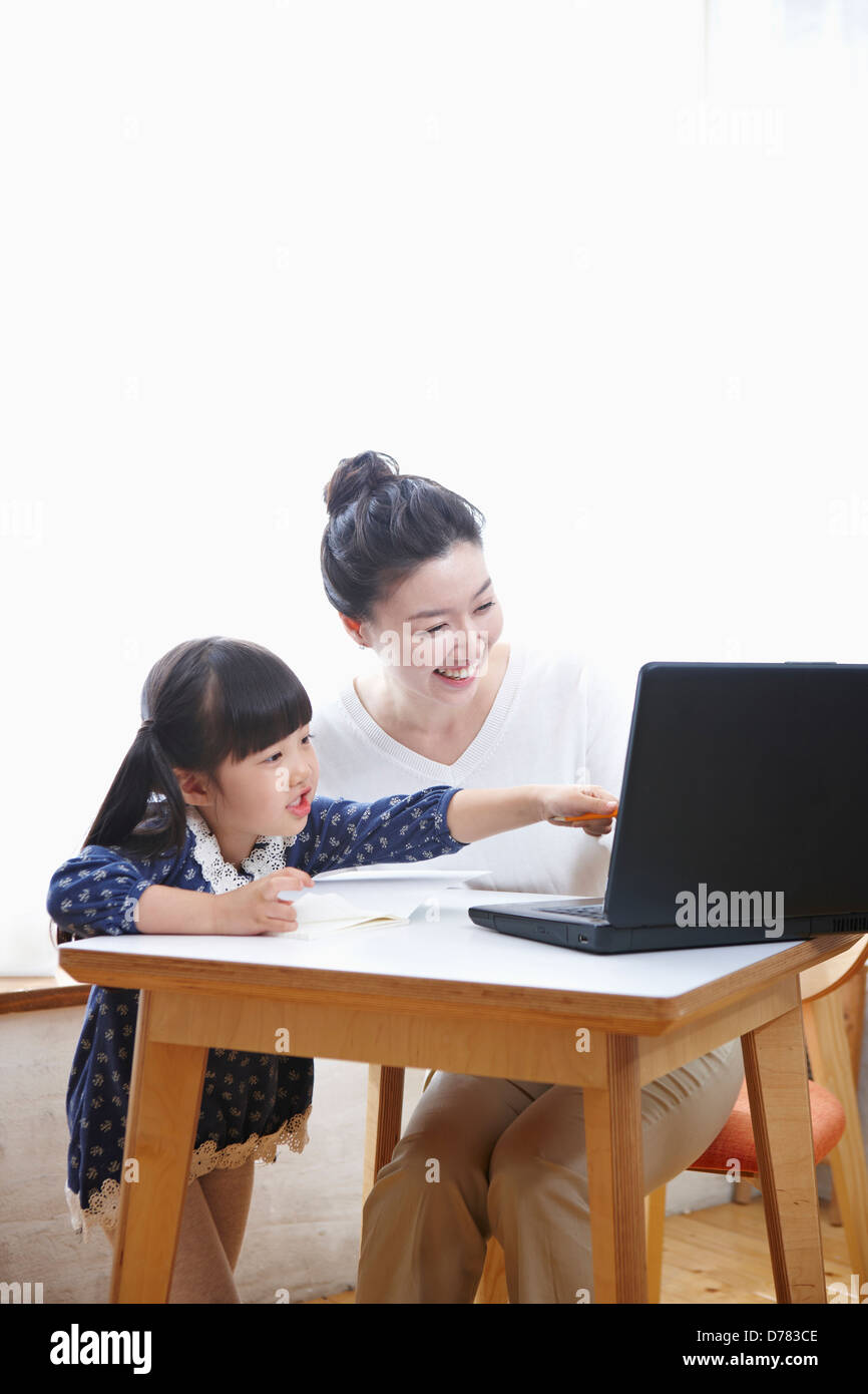 mother and daughter looking at laptop screen together Stock Photo - Alamy