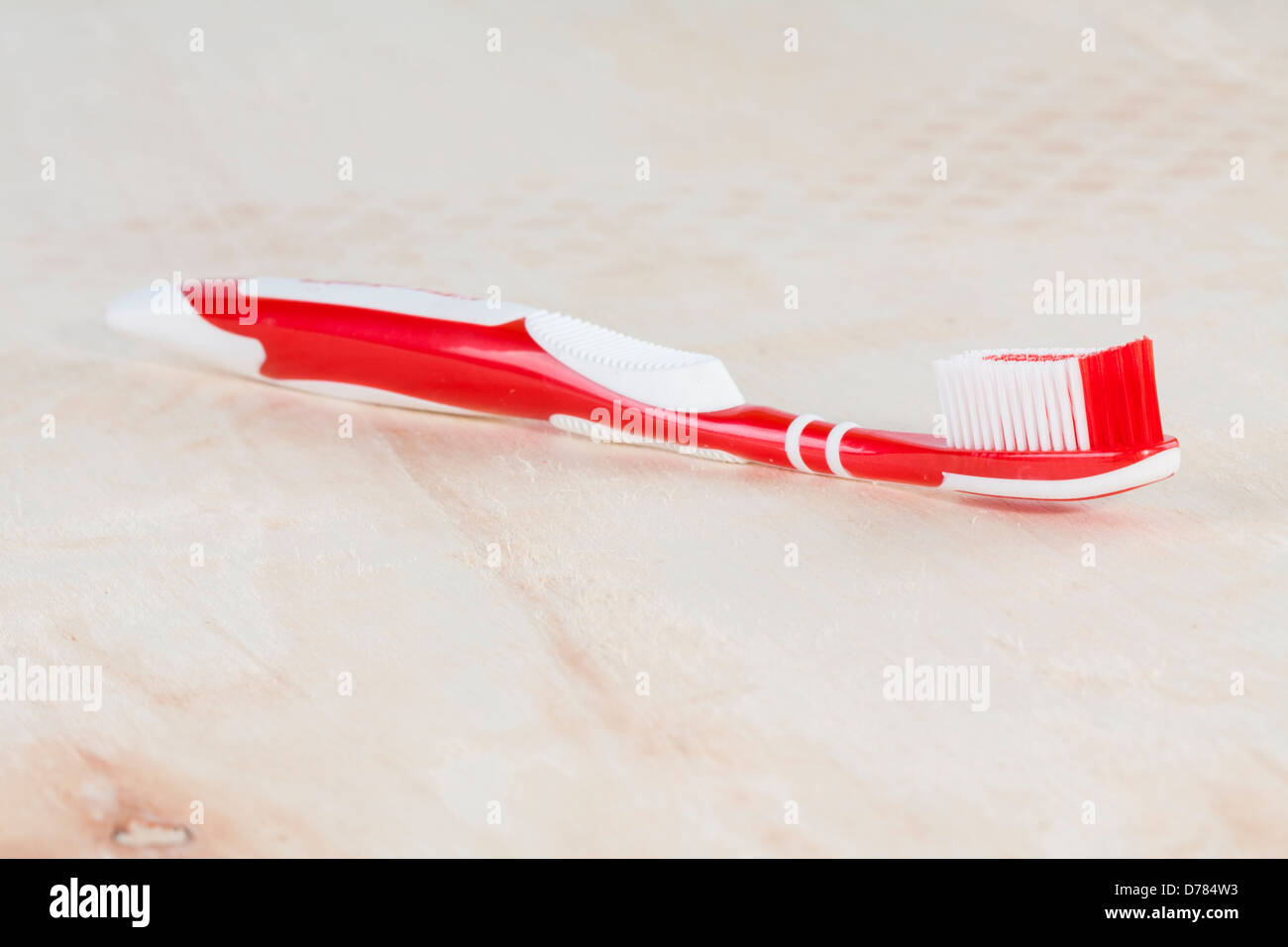 red white toothbrush with wood background and space for text Stock ...