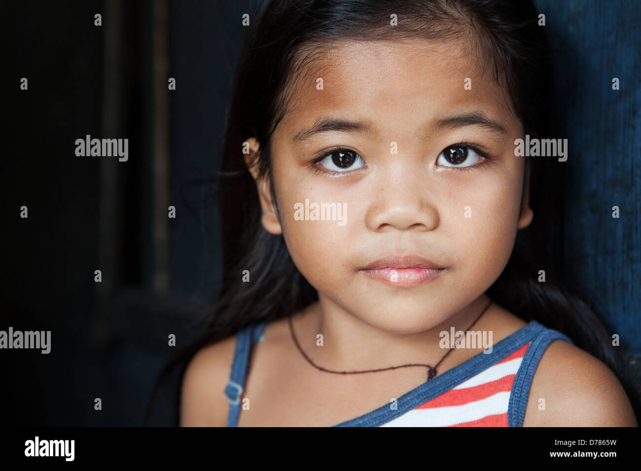Asian child portrait - young girl from the Philippines against wall ...