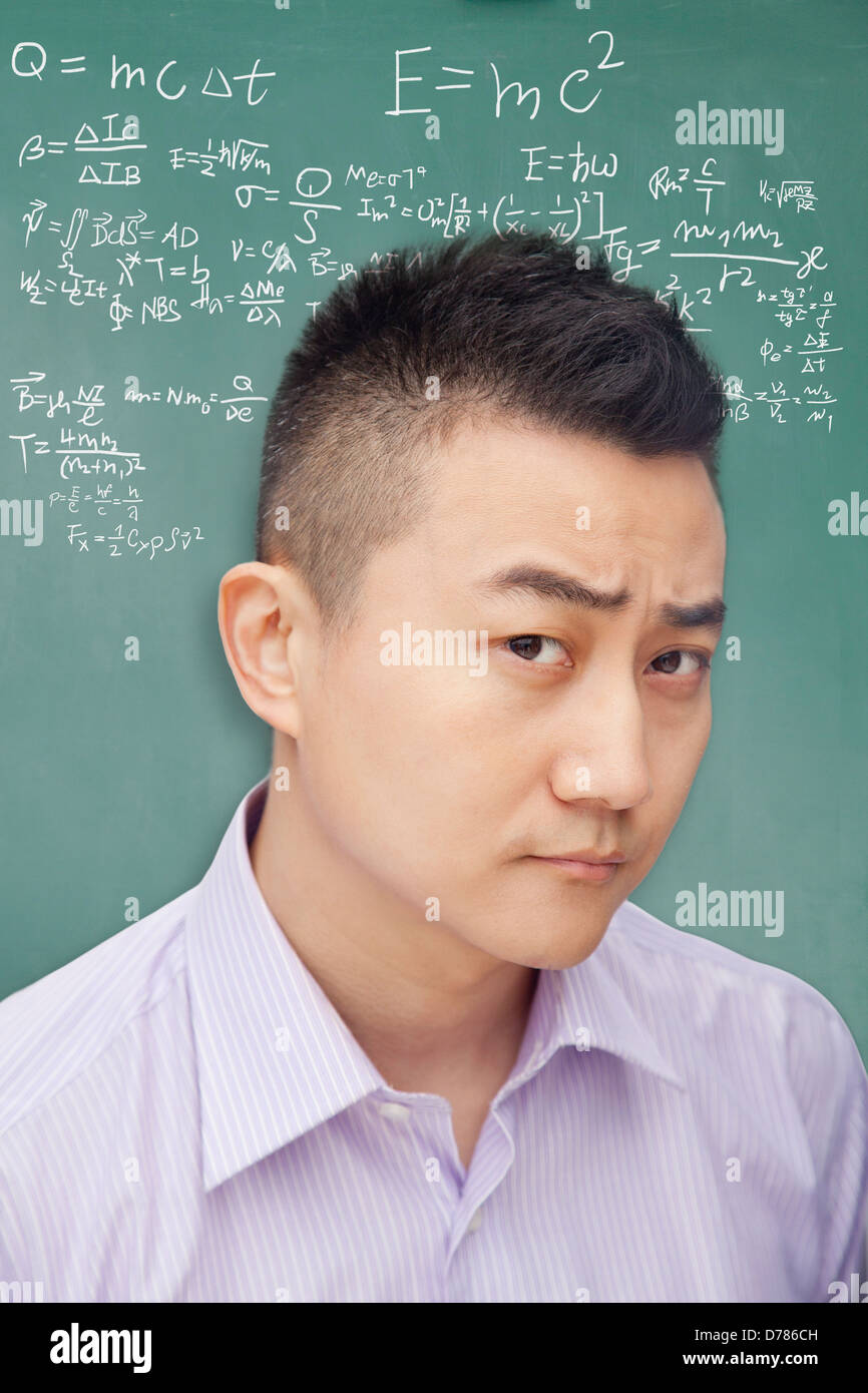 Young student in front of blackboard, making a face, portrait Stock ...