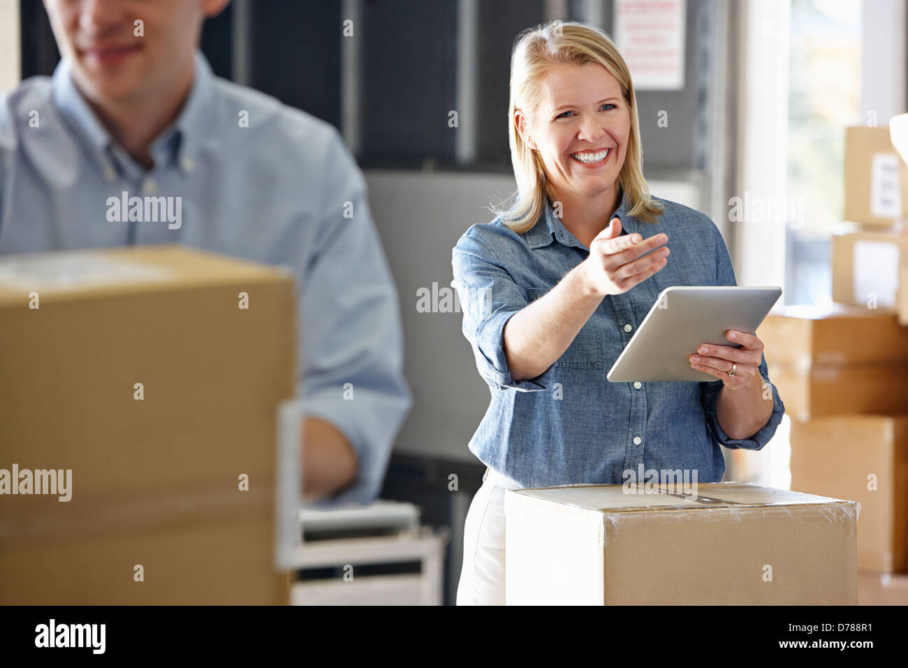 Manager Using Tablet Computer In Distribution Warehouse Stock Photo - Alamy