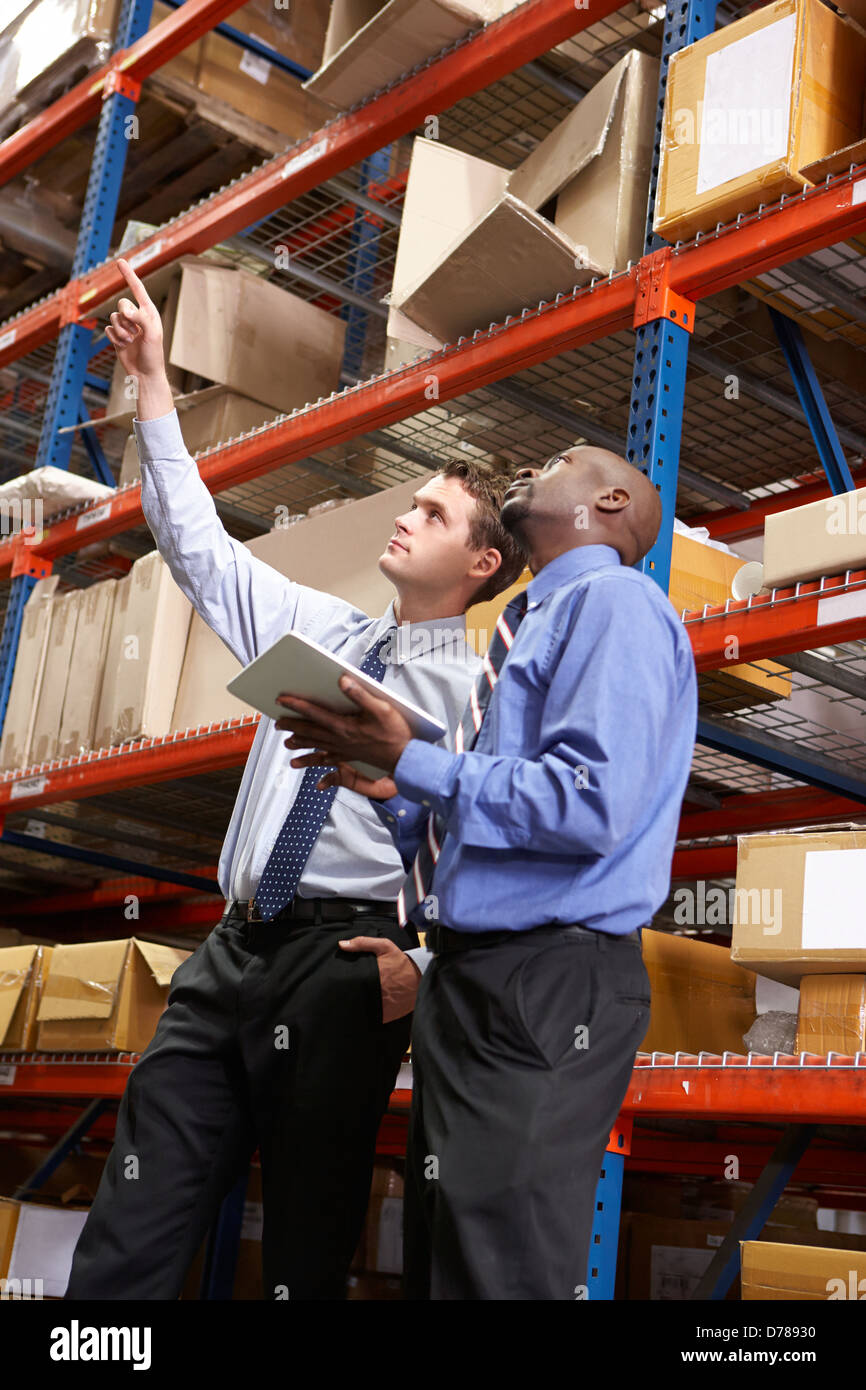 Two Businessmen With Digital Tablet In Warehouse Stock Photo - Alamy