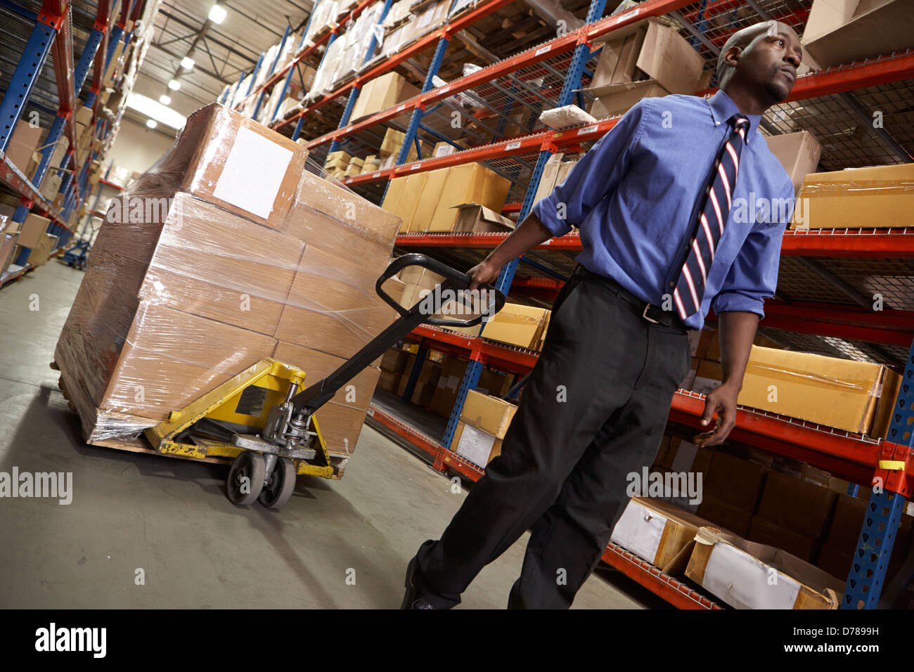 Man Pulling Pallet In Warehouse Stock Photo - Alamy