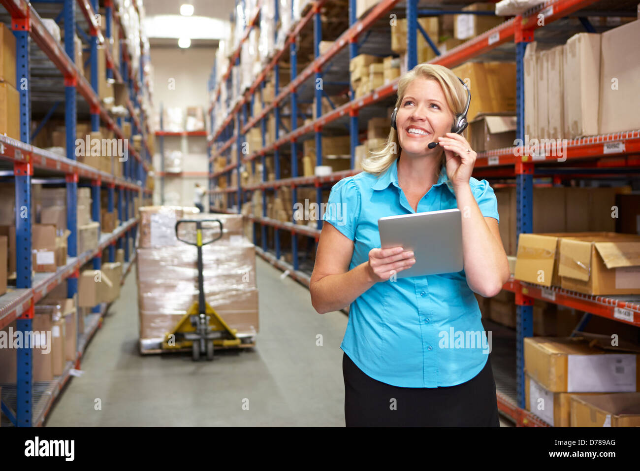 Businesswoman Using Digital Tablet In Distribution Warehouse Stock ...