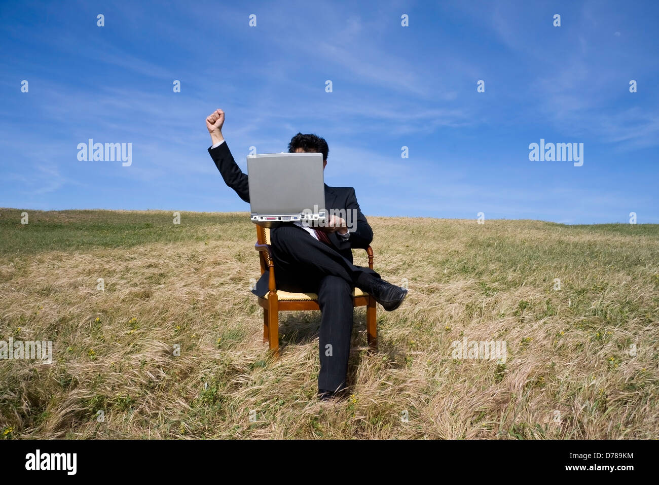 Business man sitting on a chair working out Stock Photo - Alamy