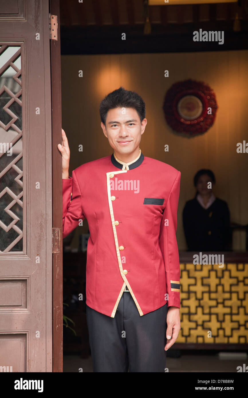 Bellhop at Hotel Entrance Stock Photo - Alamy
