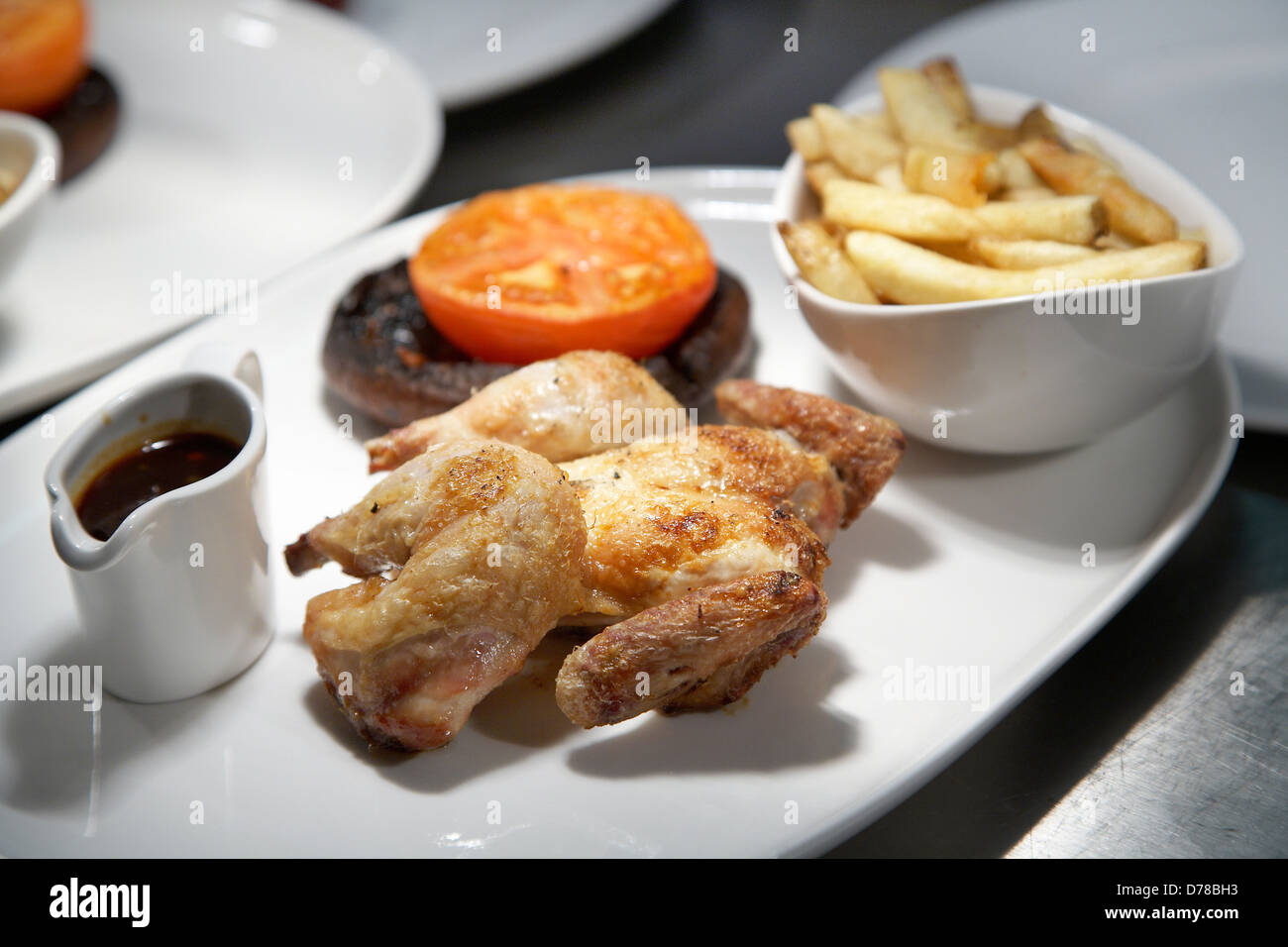 A small roast chicken ( poussin ) with fries, field mushroom, grilled ...