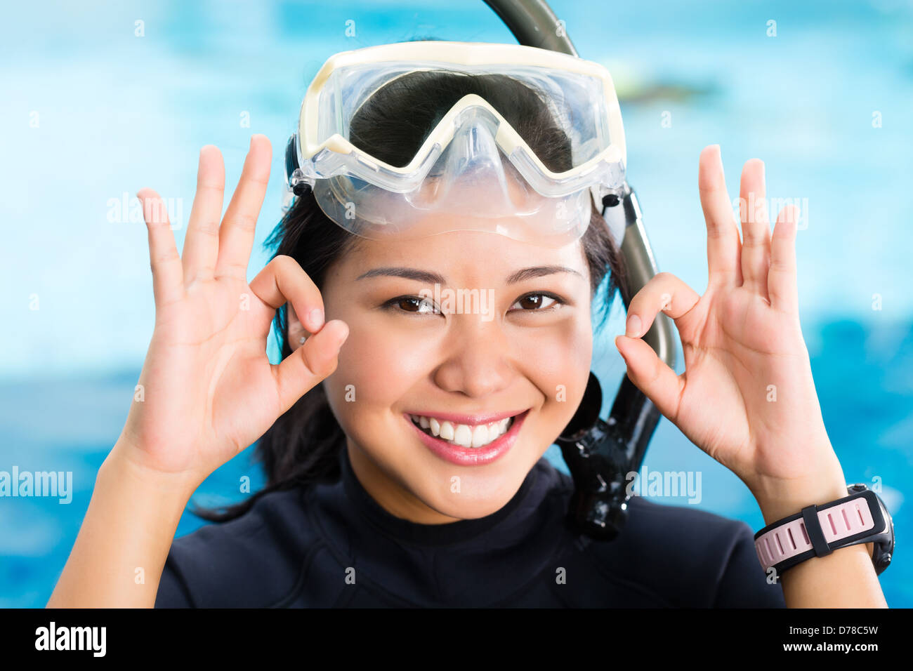 Indonesian female diver with glasses and snorkel in a diving school ...