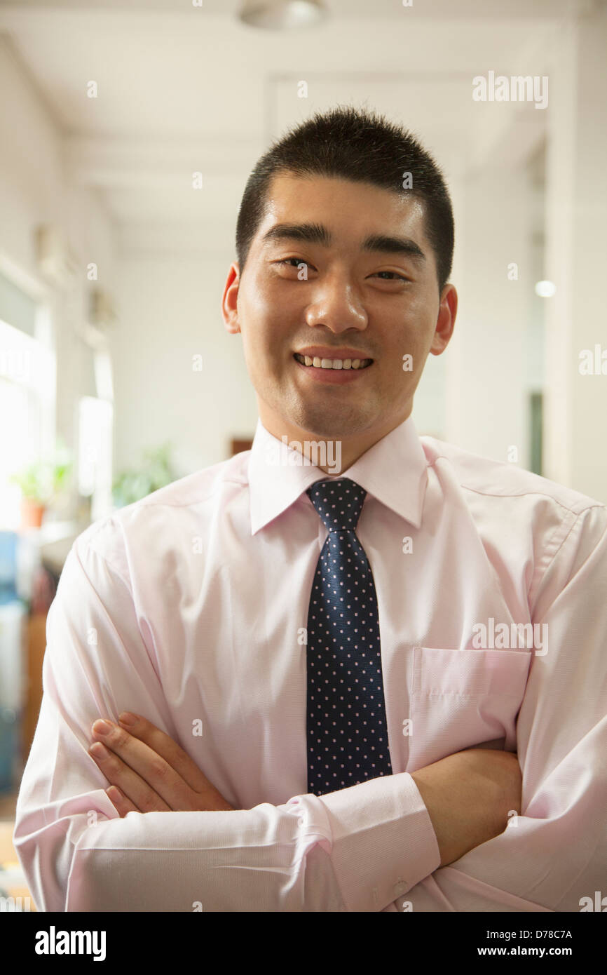 Young man smiling in the office, portrait Stock Photo - Alamy