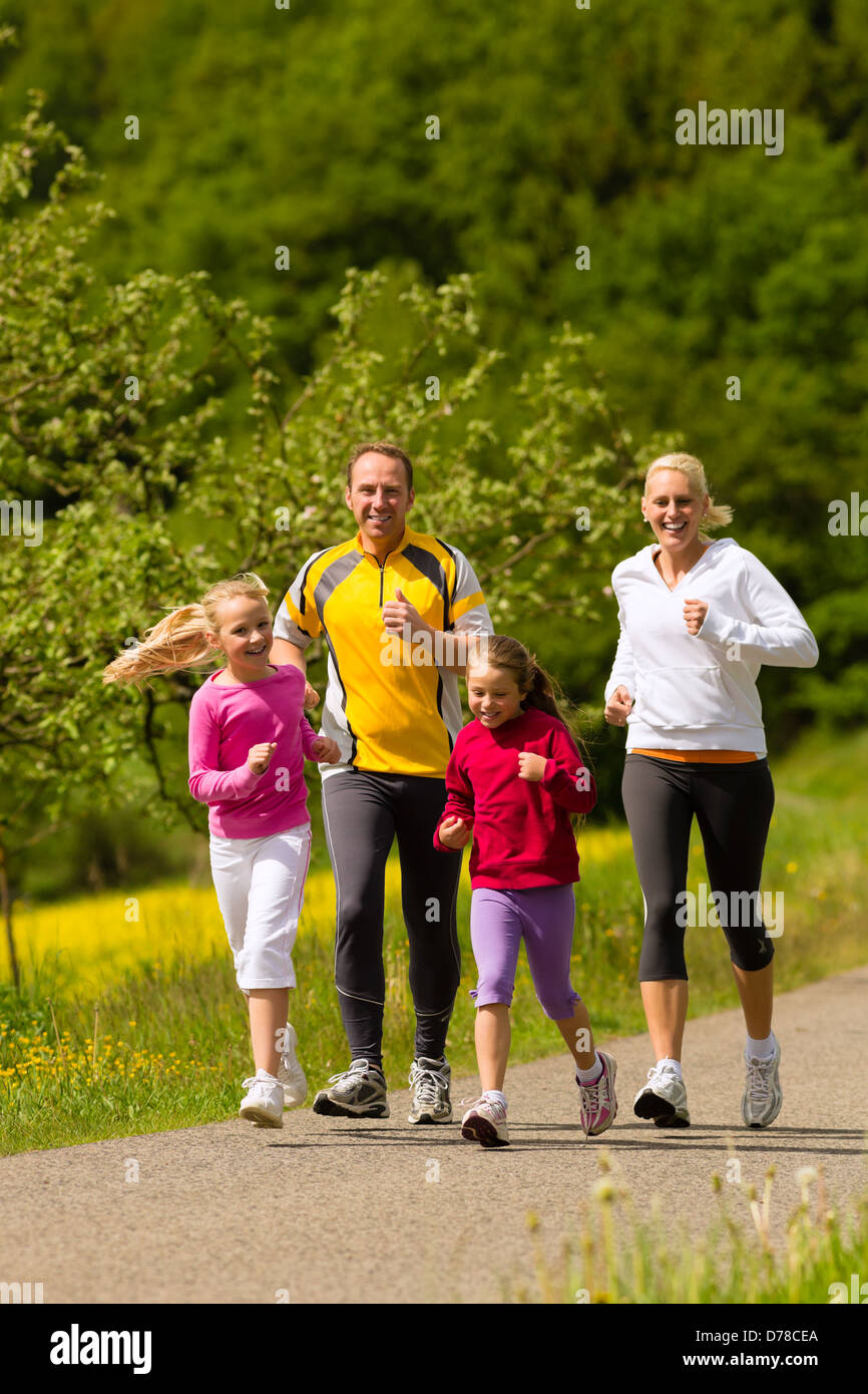 Happy Family with two girls running or jogging for sport and better ...
