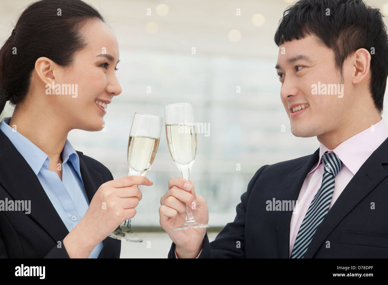 Young business man and woman toasting with champagne flutes Stock Photo ...