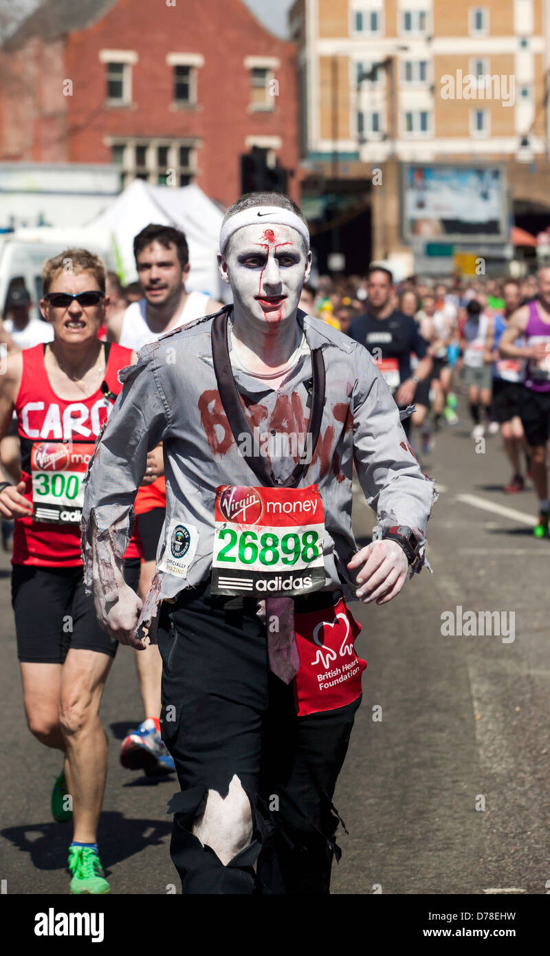 A man dressed as a zombie, running in the 2013 London Marathon Stock ...