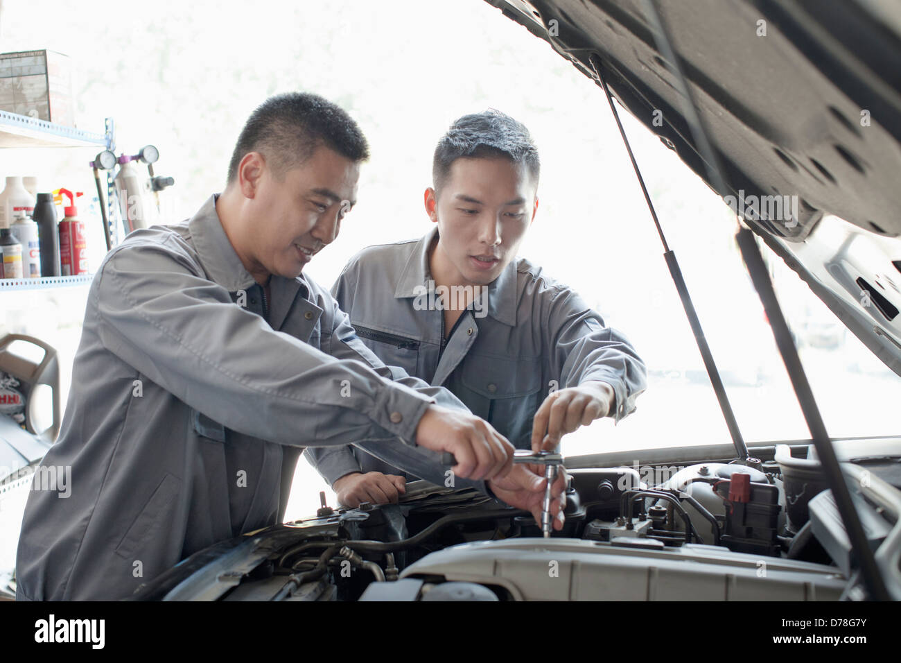 Two Garage Mechanics Working on Engine Stock Photo - Alamy