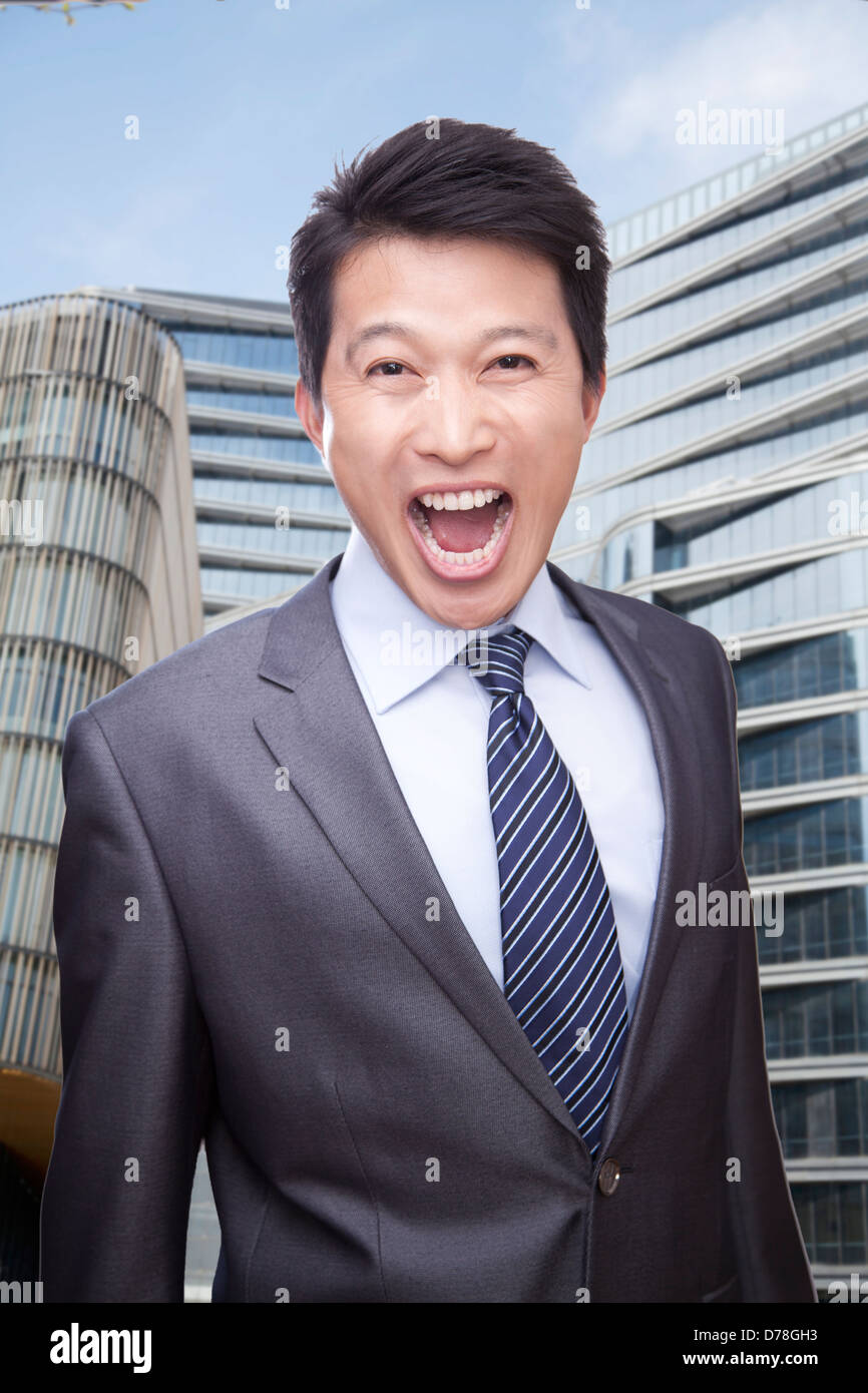 Composite image of standing businessman shouting through a megaphone ...