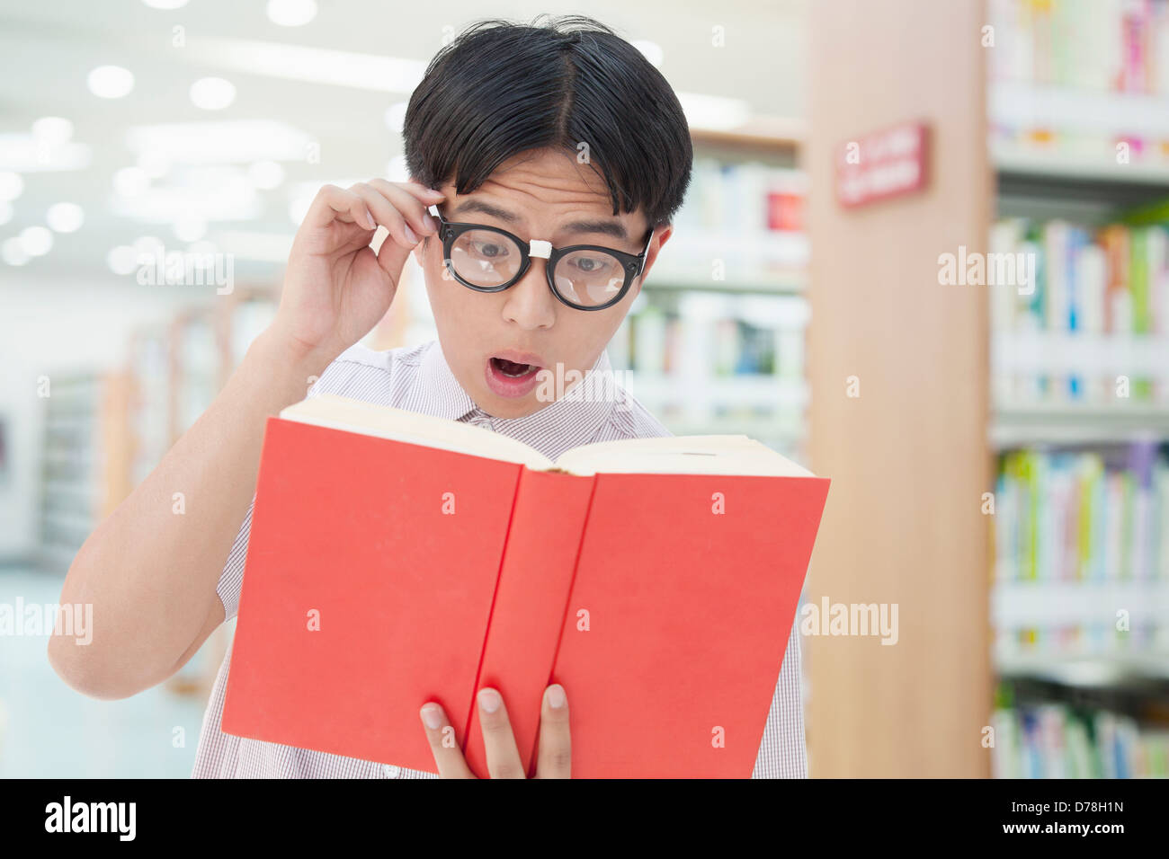 Man reading book shocked expression hi-res stock photography and images ...