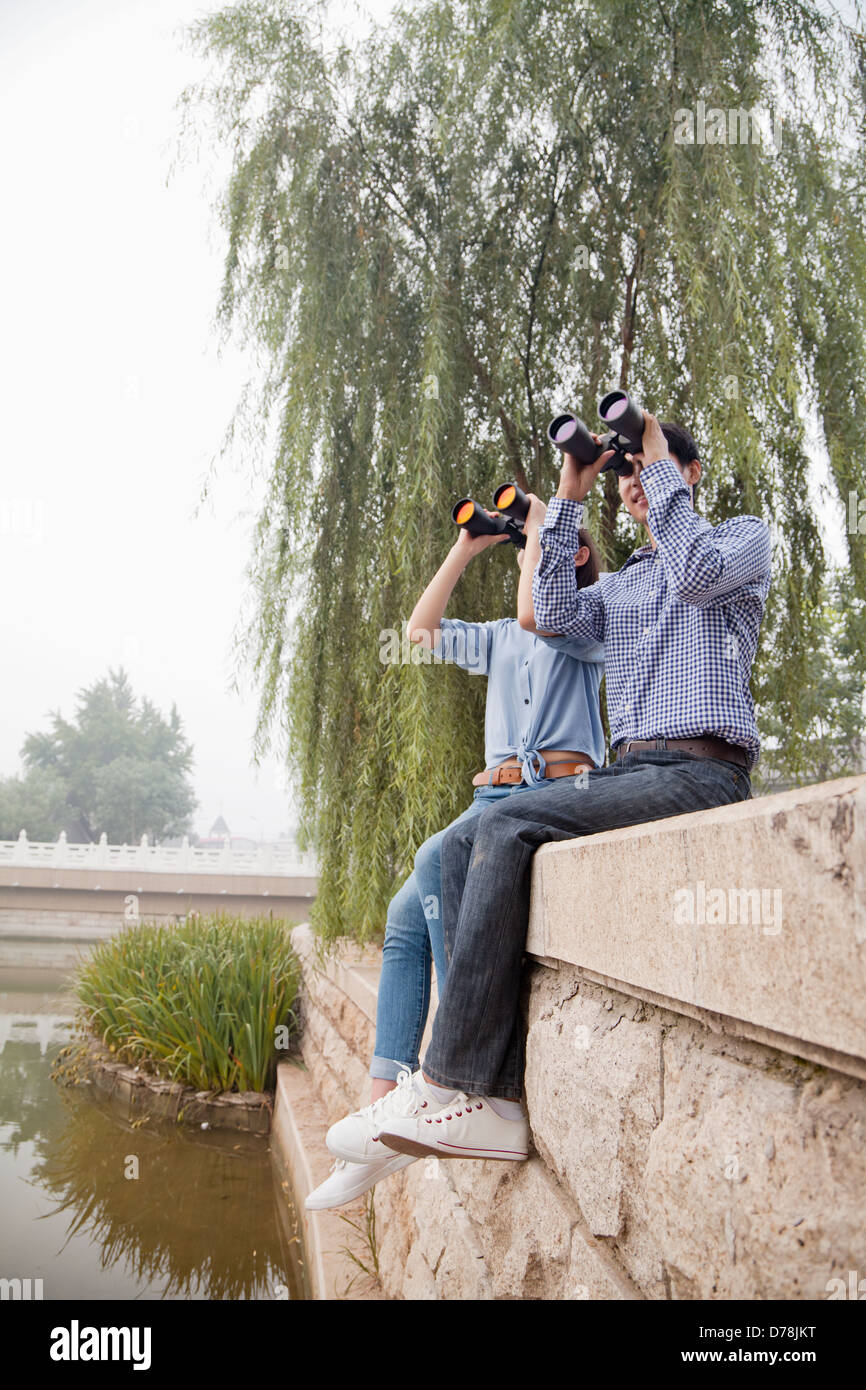 Young Couple Looking Out With Binoculars Stock Photo - Alamy