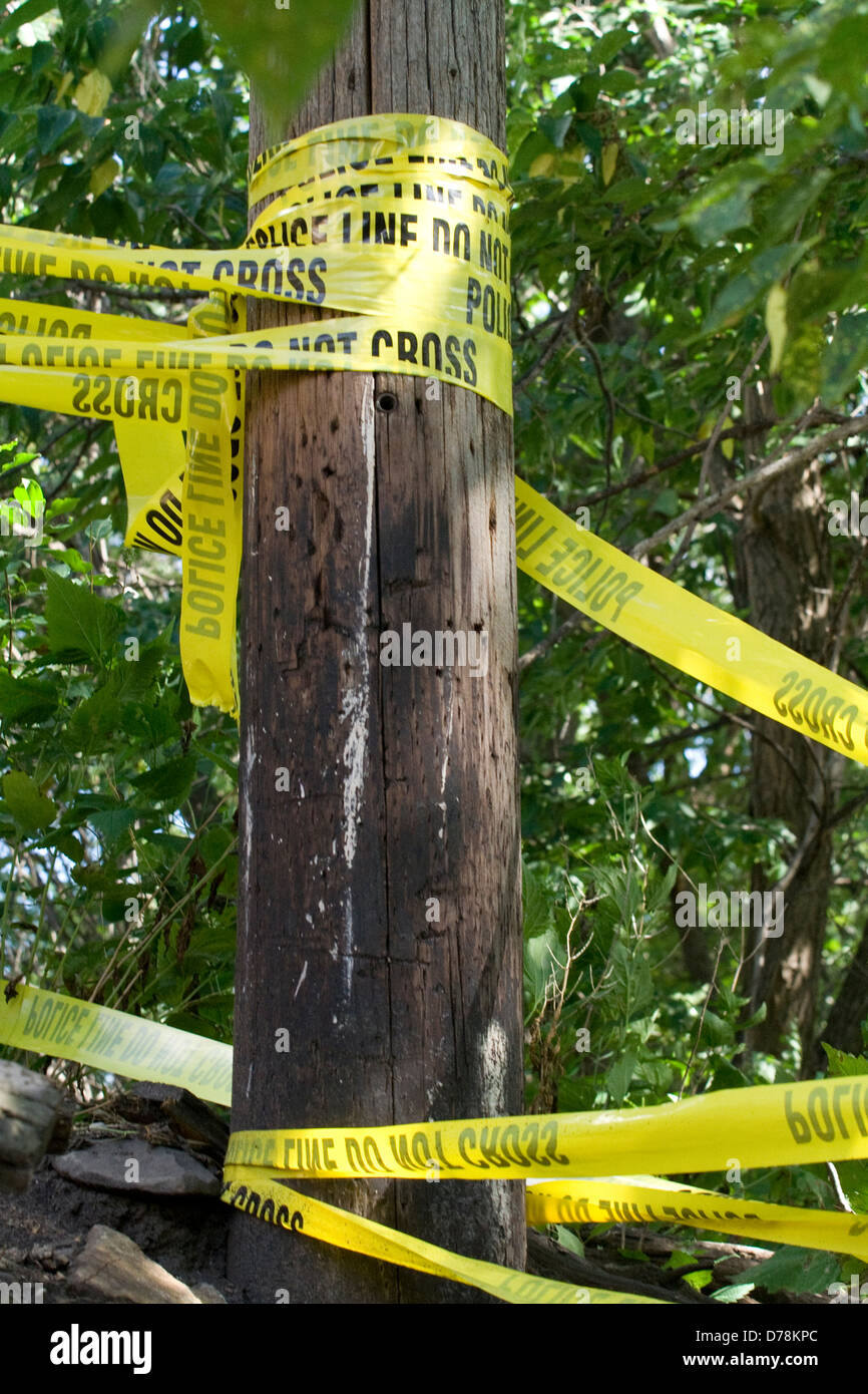 yellow police tape wrapped around and across objects. knotted and ...