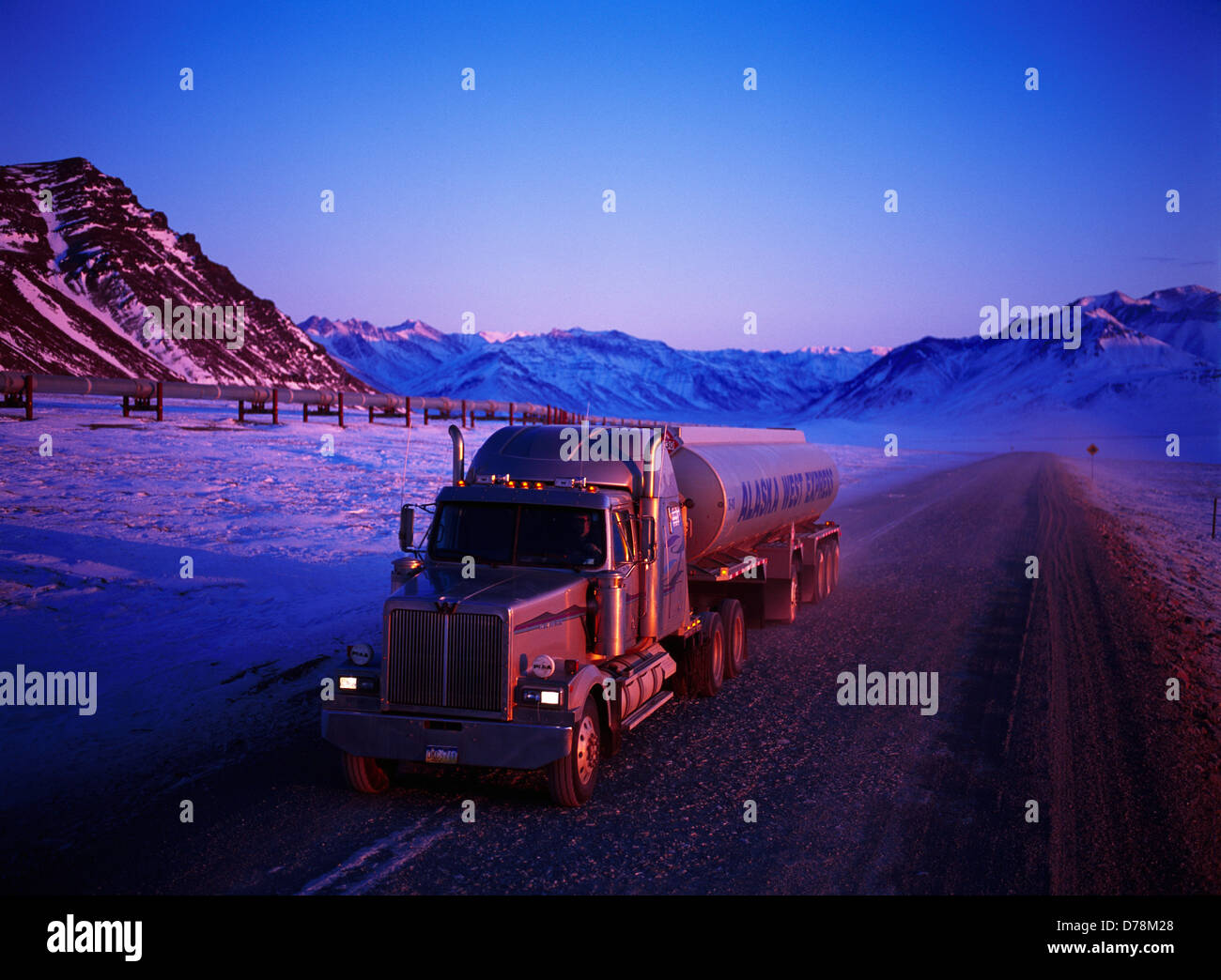 Low light winter sun illuminating Alaska West Express tanker truck ...