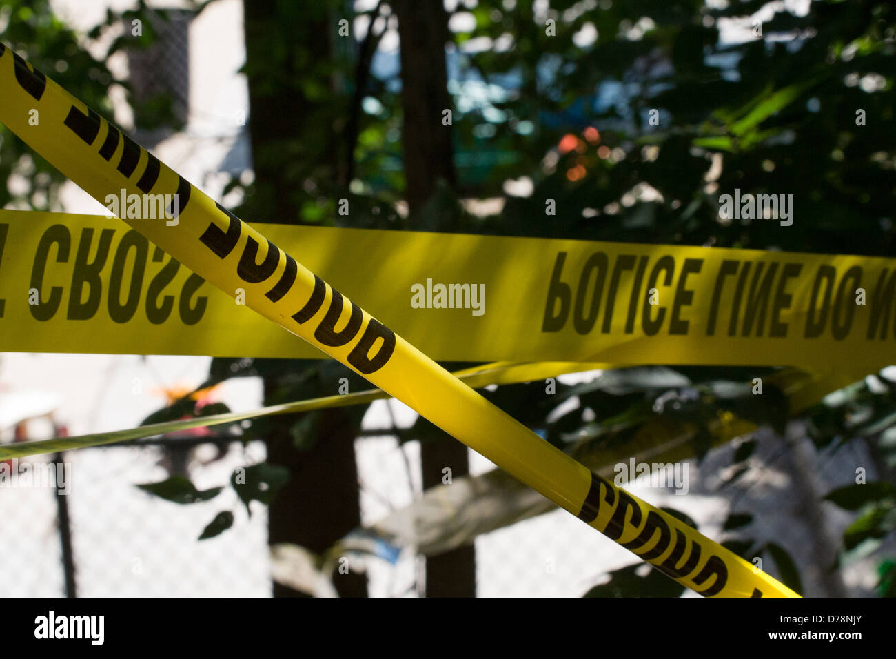 yellow police tape wrapped around and across objects. knotted and ...