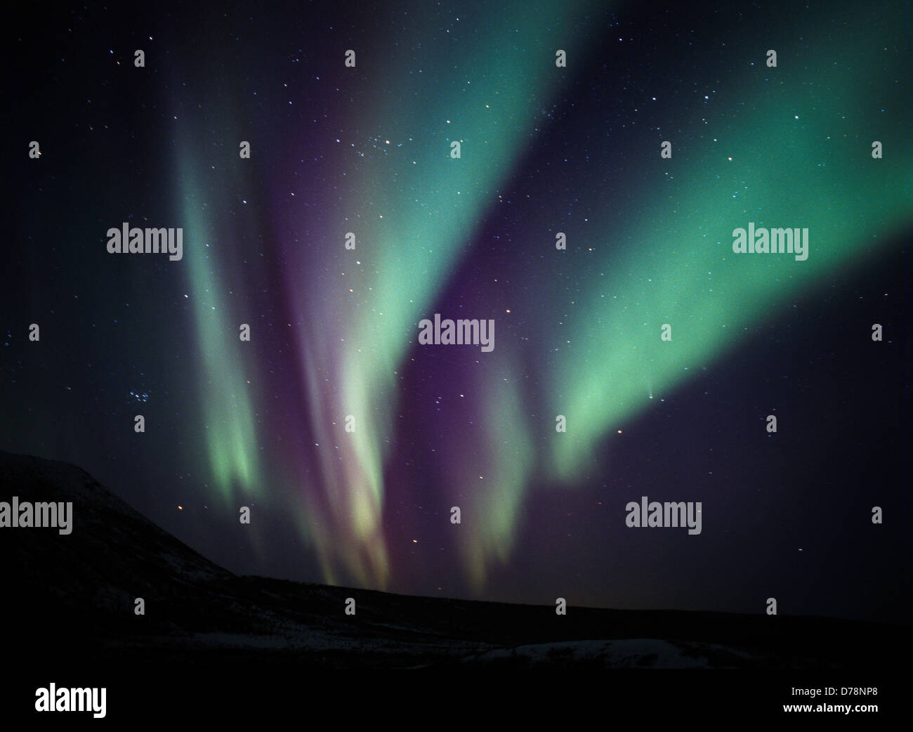 Green purplish-blue aurora above slope Donnelly Dome on north side ...