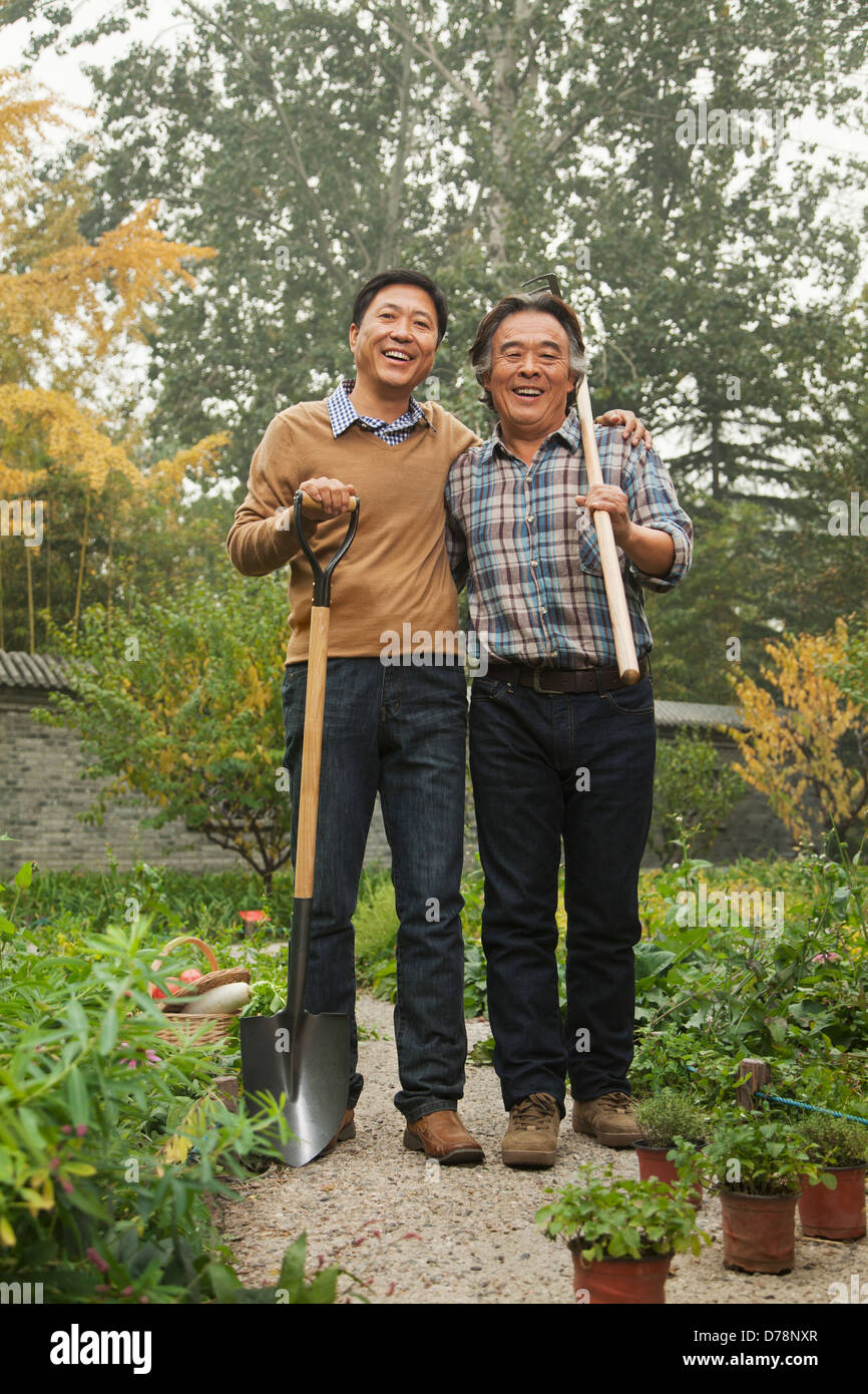 Two generation working in garden Stock Photo - Alamy