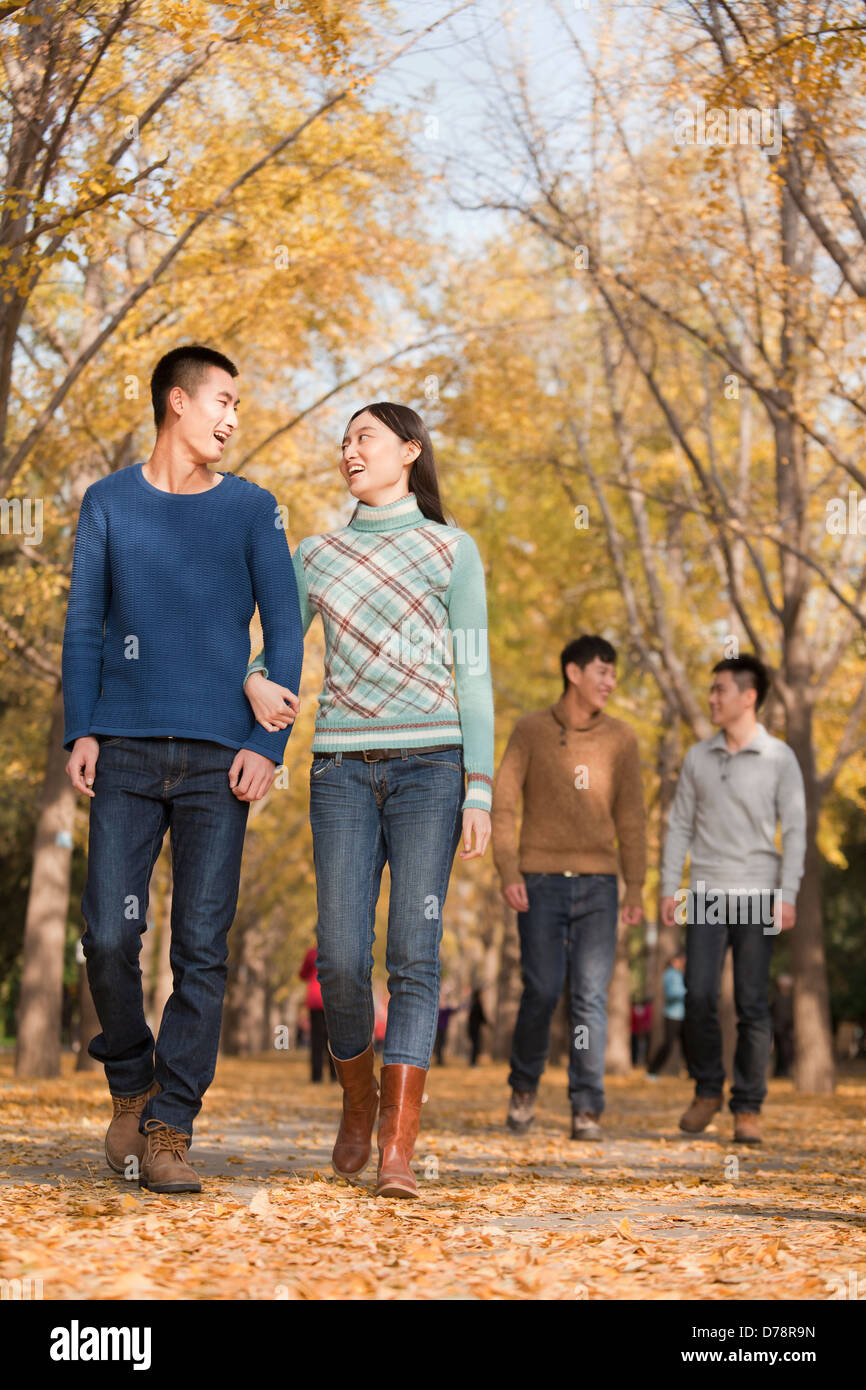 Friends walking together in park Stock Photo - Alamy