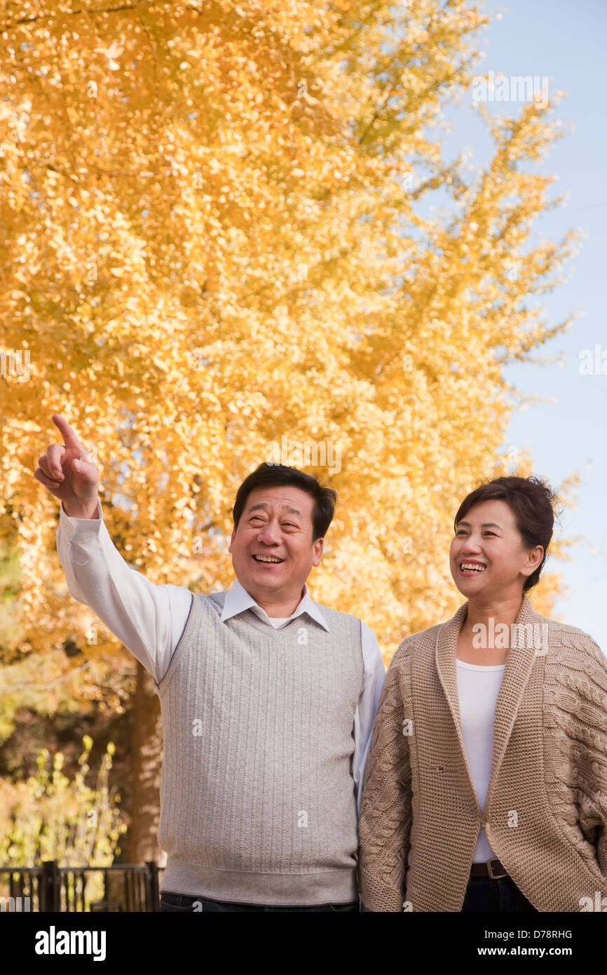 Mature Couple Walking Together in the Park Stock Photo - Alamy