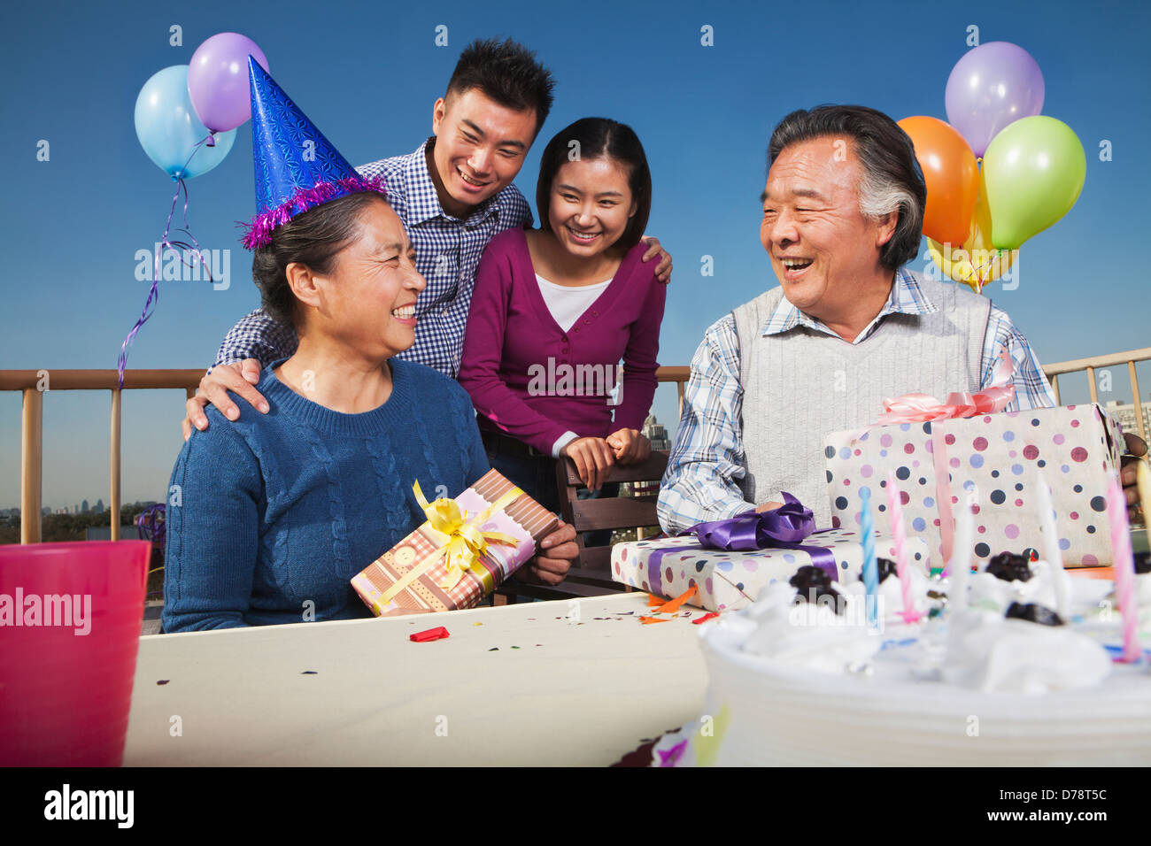 Family celebrating mum's birthday Stock Photo - Alamy