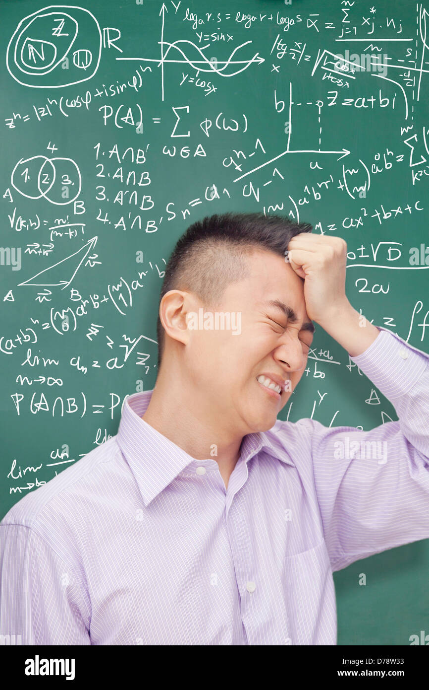 Frustrated young student in front of blackboard Stock Photo - Alamy