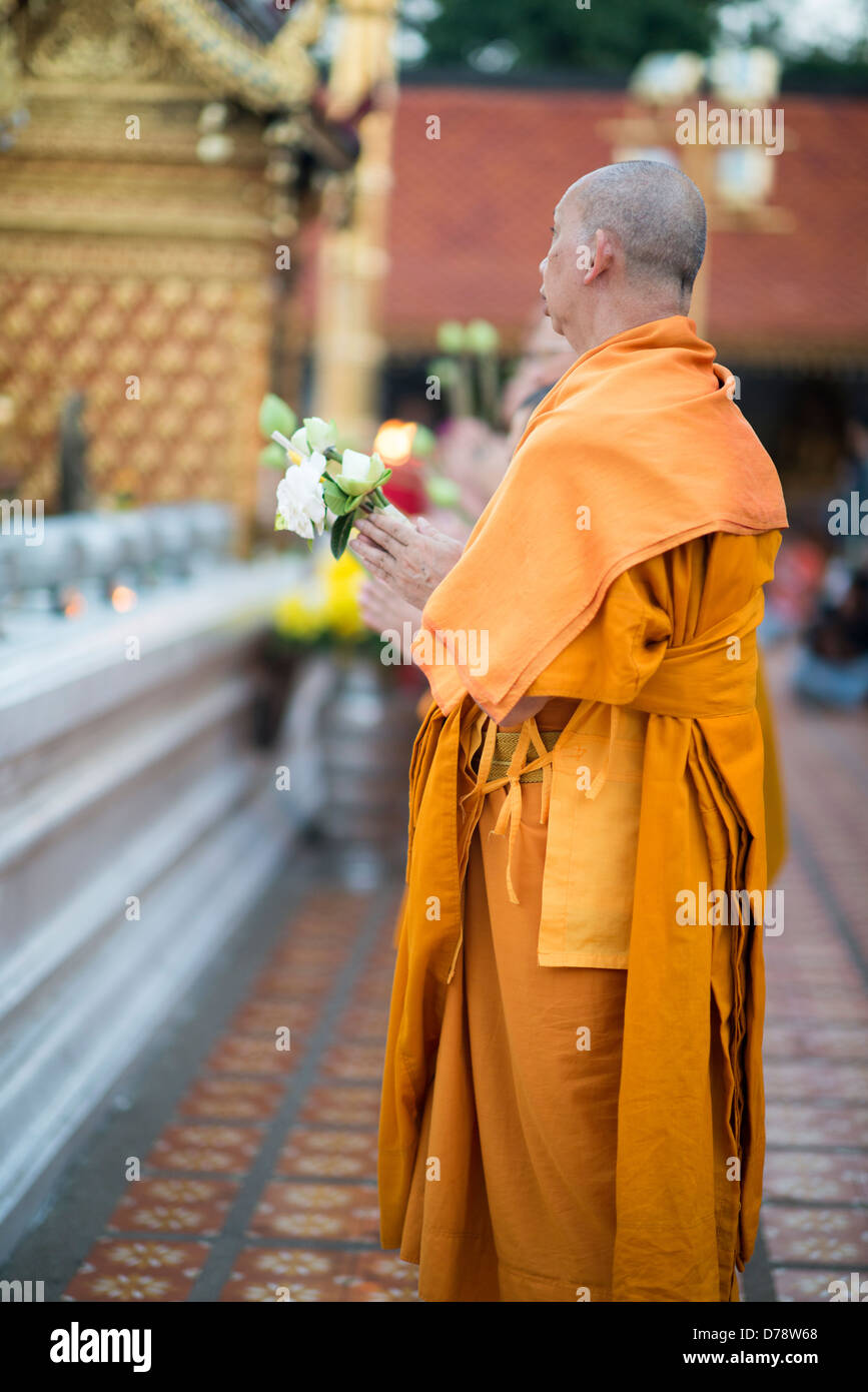 The monk holding lotus flower for prey around Chedi(Stupa) in Doi Sutep ...