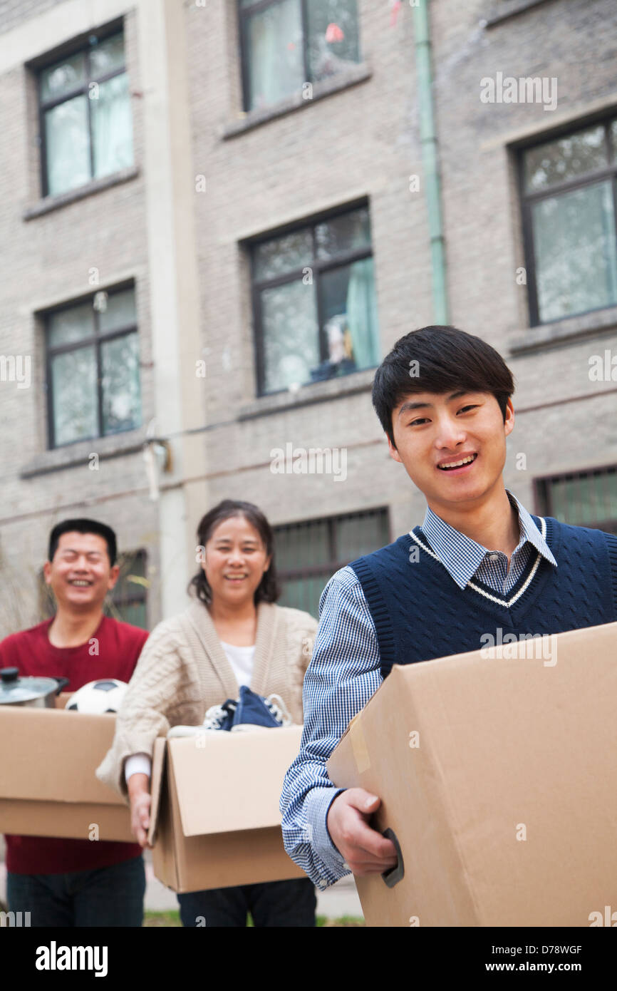 Family moving boxes into a dormitory at college Stock Photo - Alamy