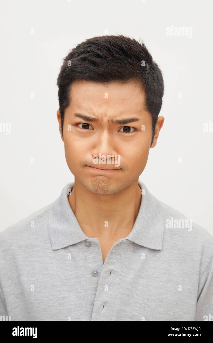 Portrait of angry and frustrated young man, studio shot Stock Photo - Alamy