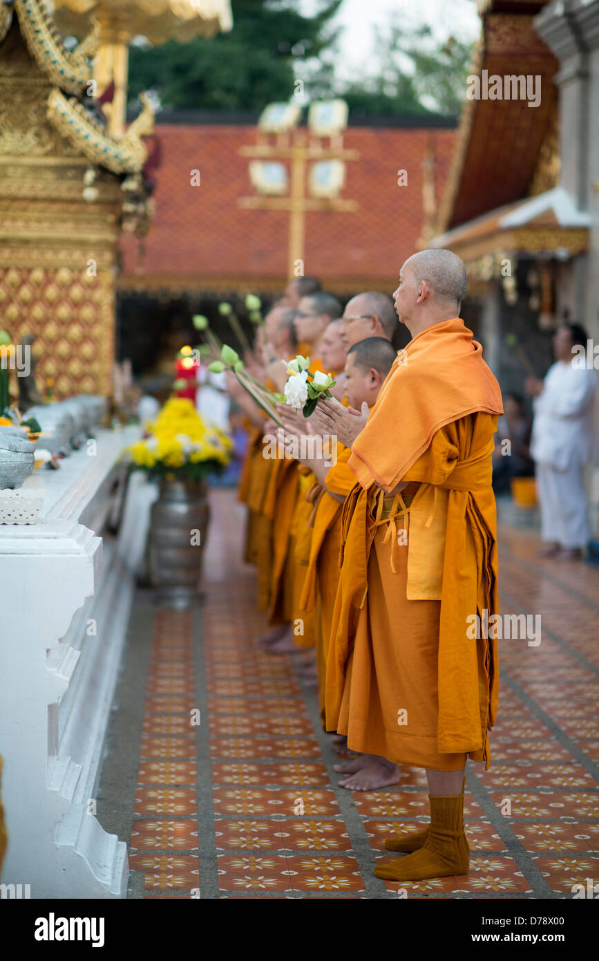 The monk holding lotus flower for prey around Chedi(Stupa) in Doi Sutep ...