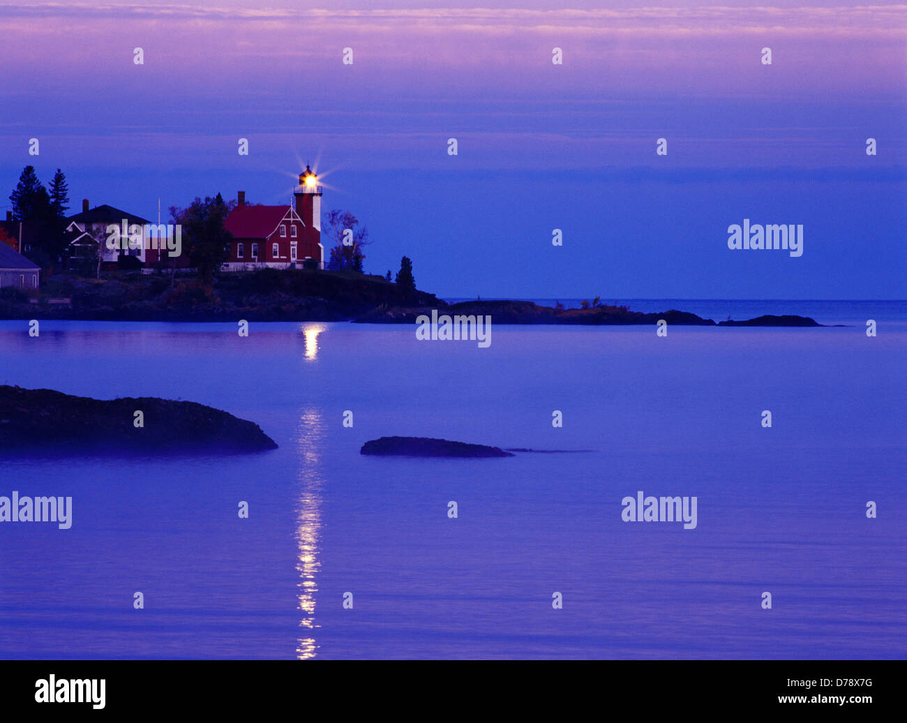 Eagle Harbor Lighthouse built in 1871 reflected in Eagle Harbor on ...