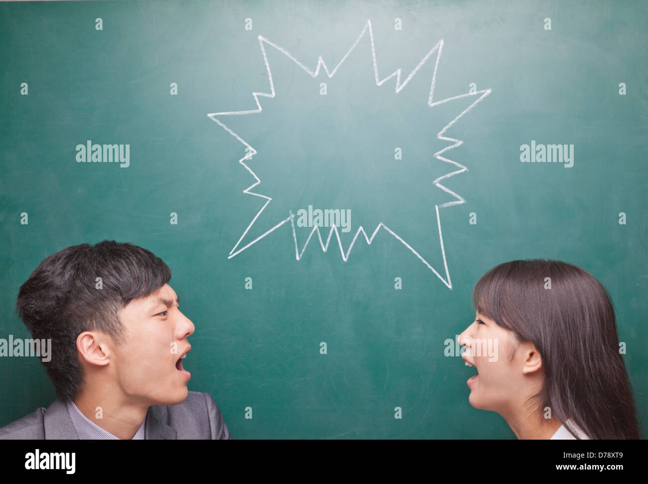 Two young people yelling at each other in front of blackboard Stock ...