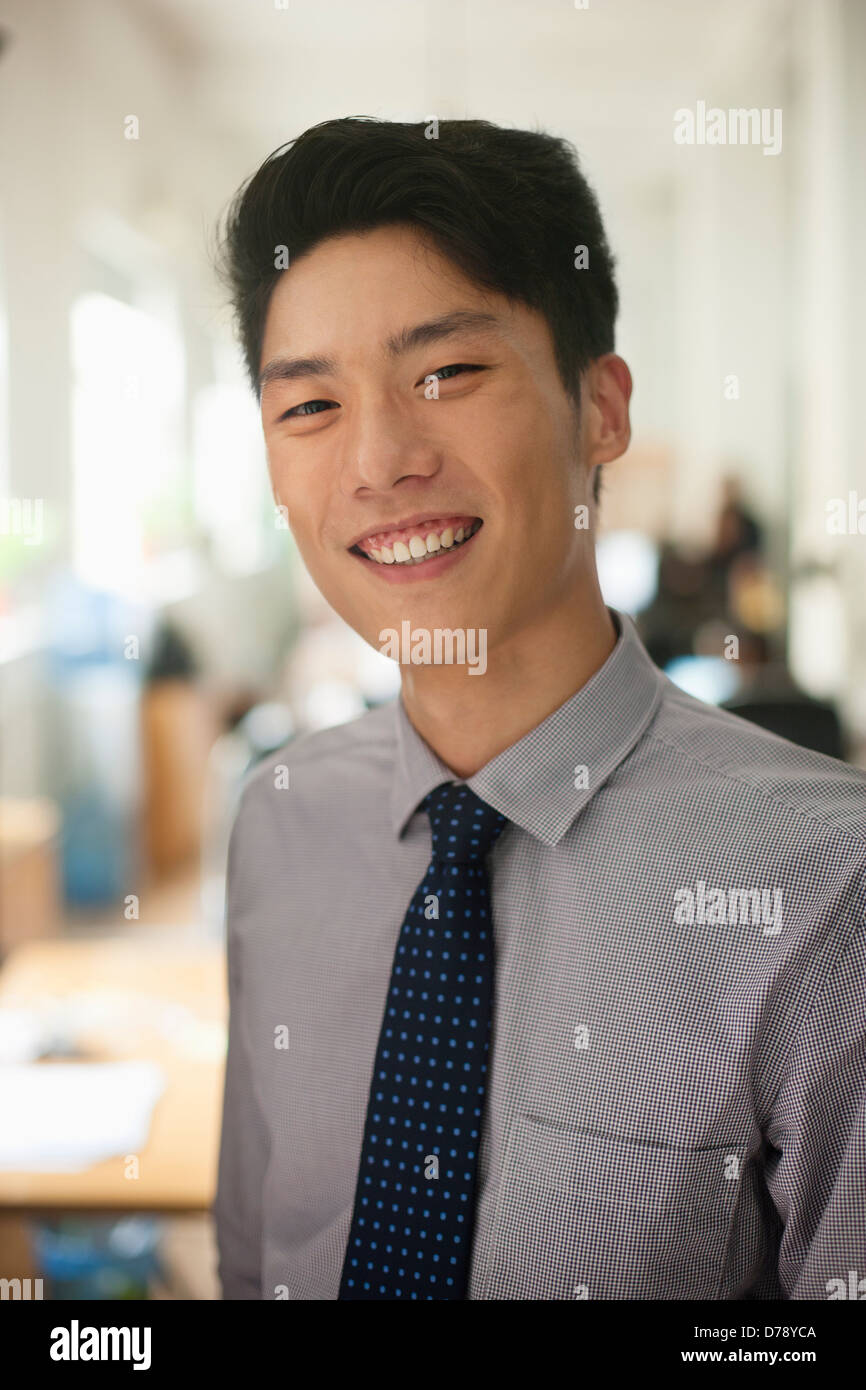 Young man smiling in the office, portrait Stock Photo - Alamy