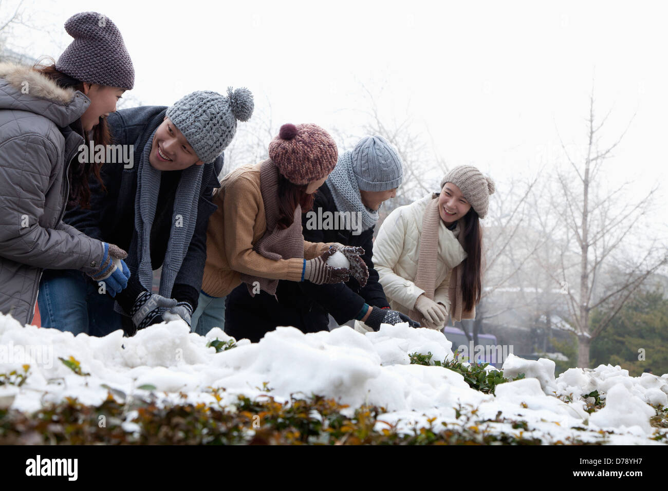 Group of Friends Playing in the Snow Stock Photo - Alamy
