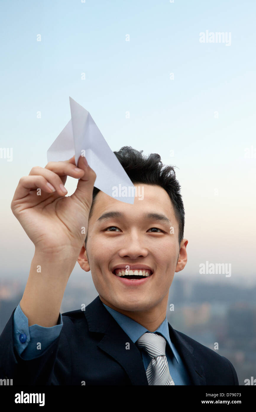 Businessman Flying Paper Airplane Stock Photo - Alamy