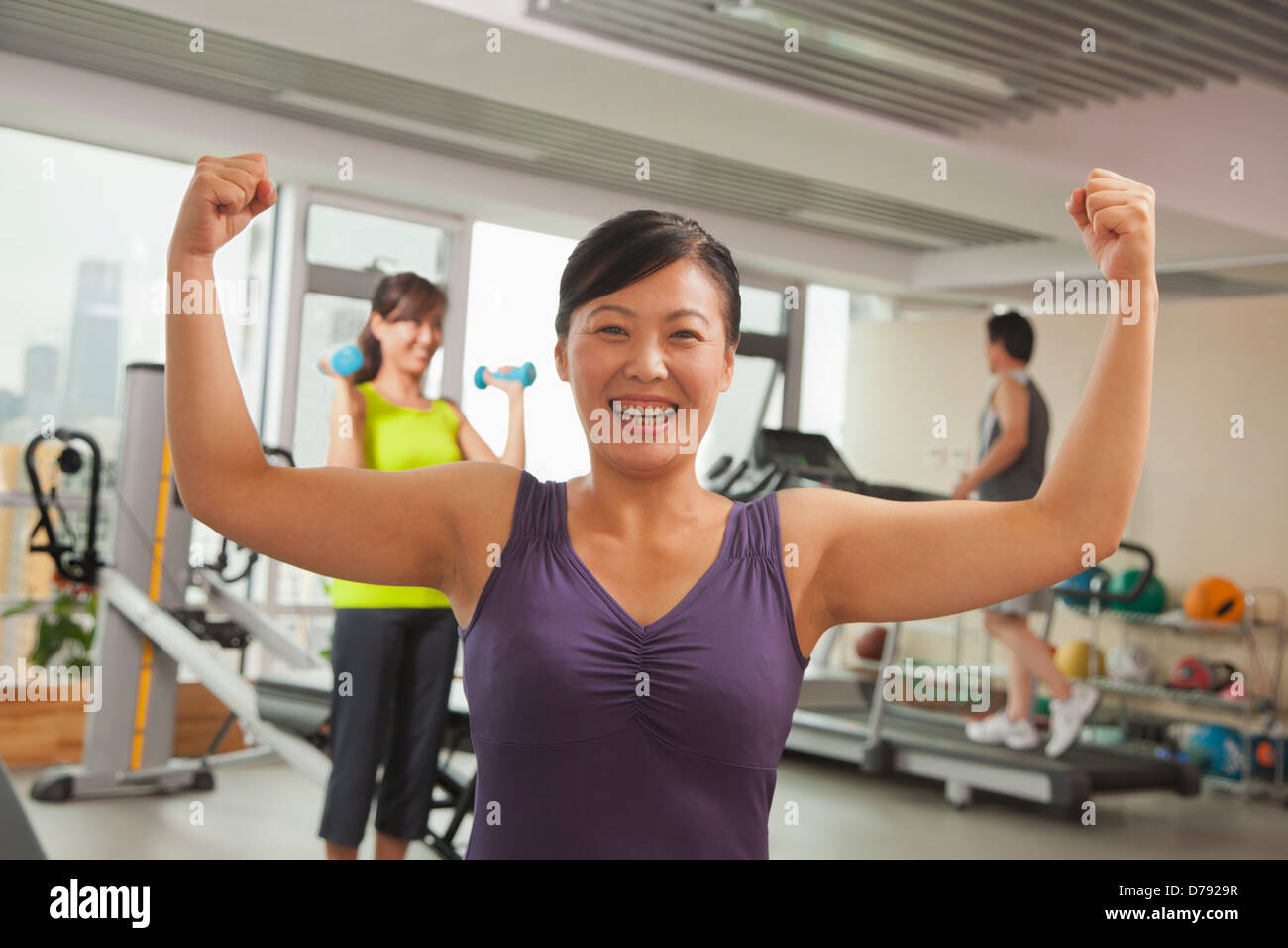 Mature women showing her strength after workout in the gym Stock Photo ...