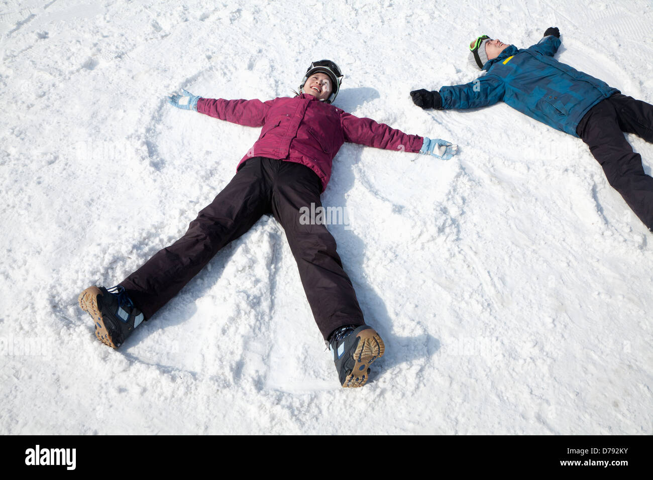 Man and Woman Lying on the Snow Making Snow Angel Stock Photo - Alamy