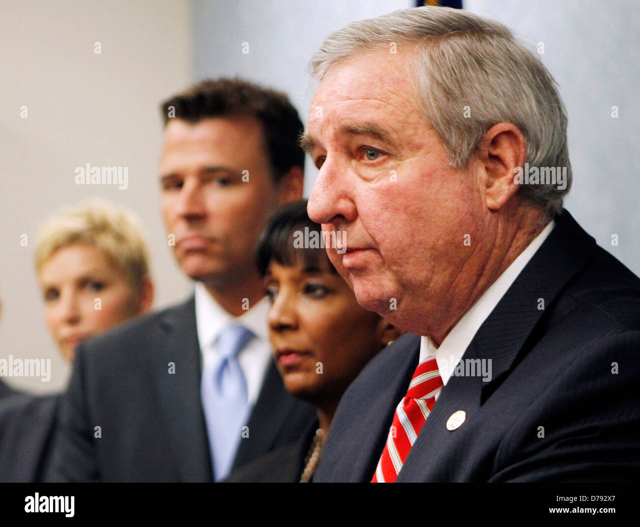 District Attorney Steve Cooley, right, speaks to the media as, left to ...