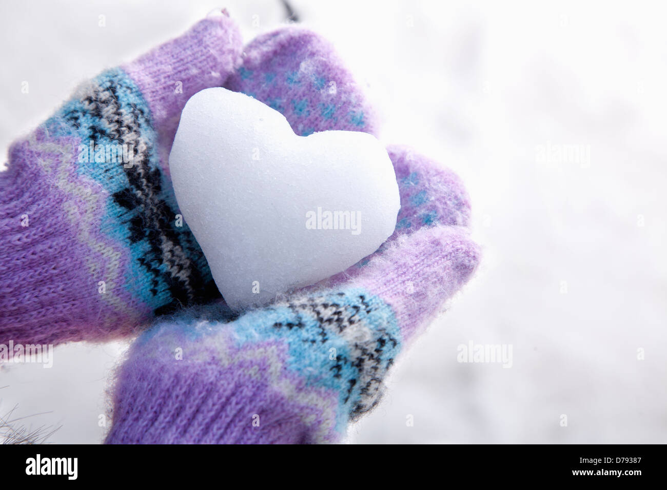 Snow Heart in Hands with Mittens Stock Photo - Alamy