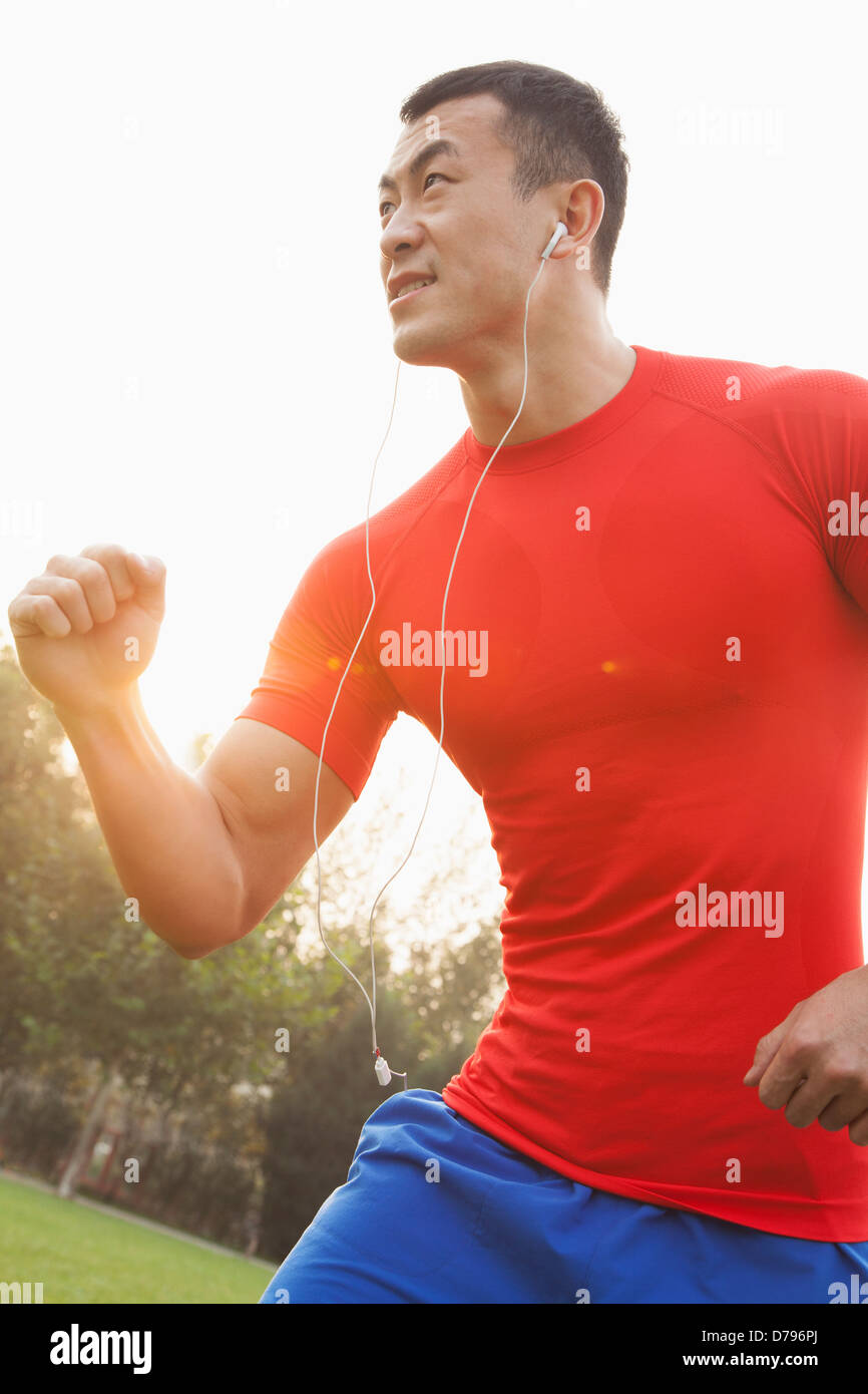 Muscular Man Running and Listening to Music Stock Photo - Alamy