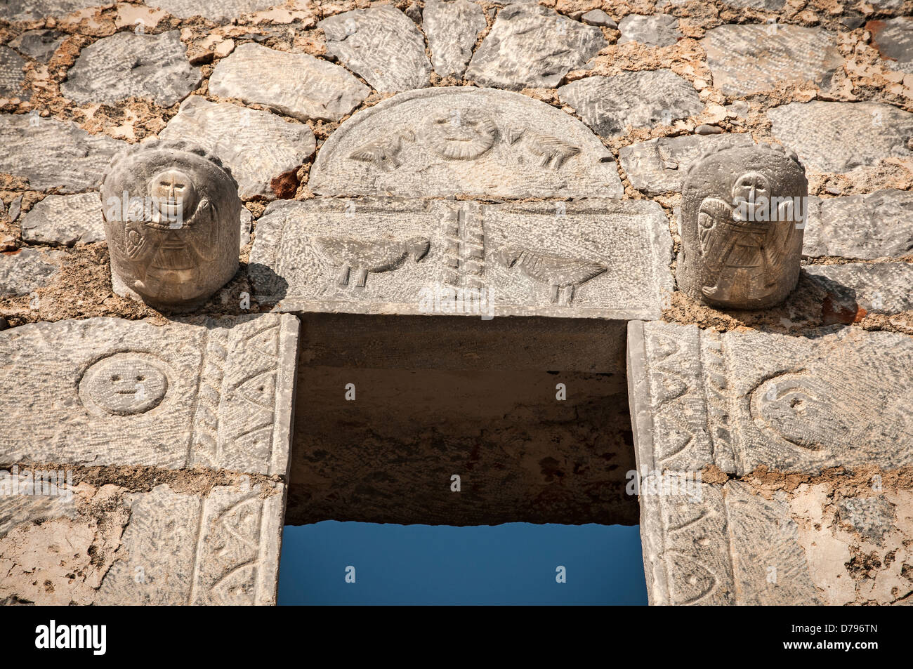 Traditional Maniot stone carving of angels and birds on a window in the ...